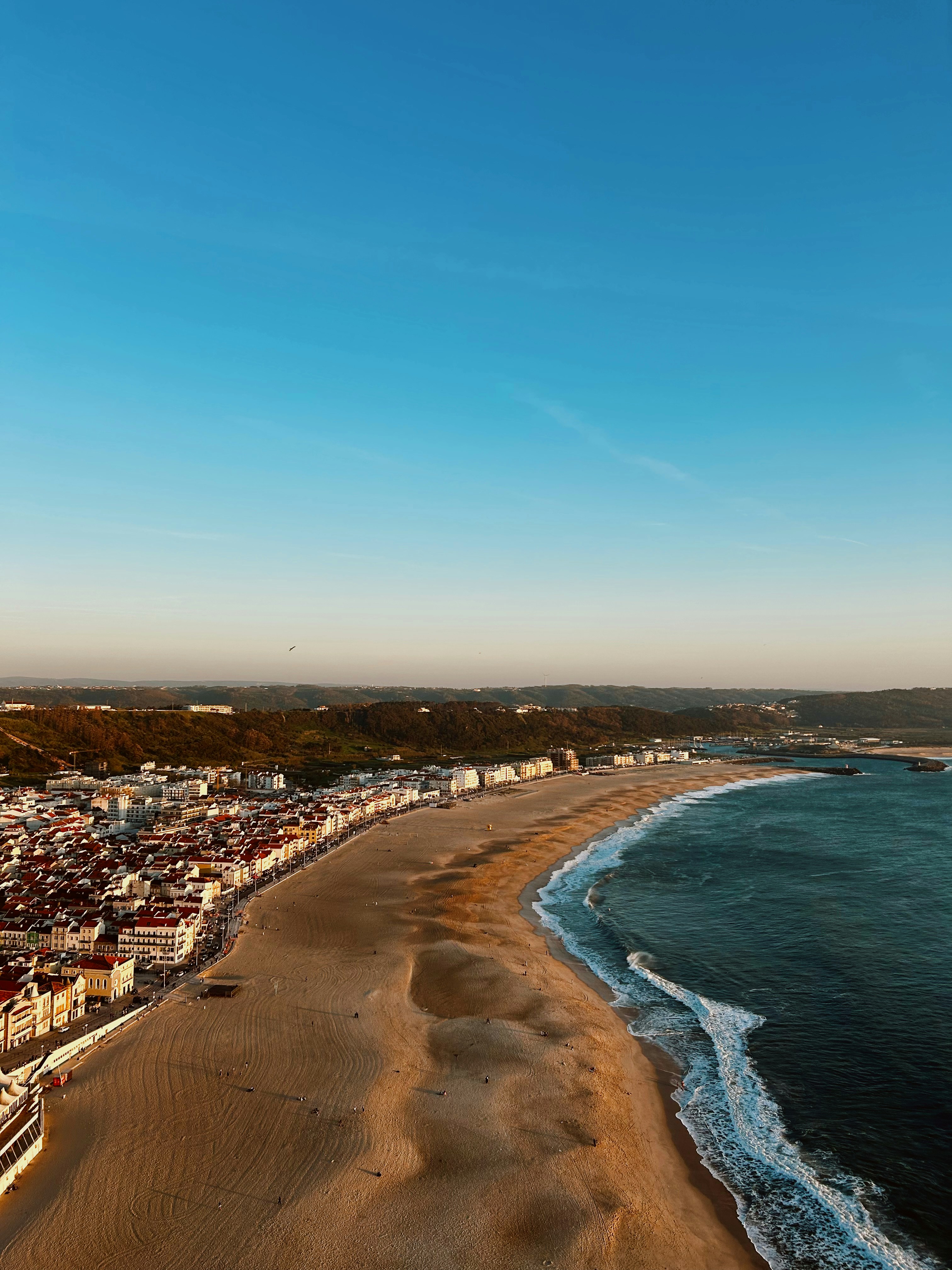 Coastal Dunes and Seaside Village Bowing to the Horizon