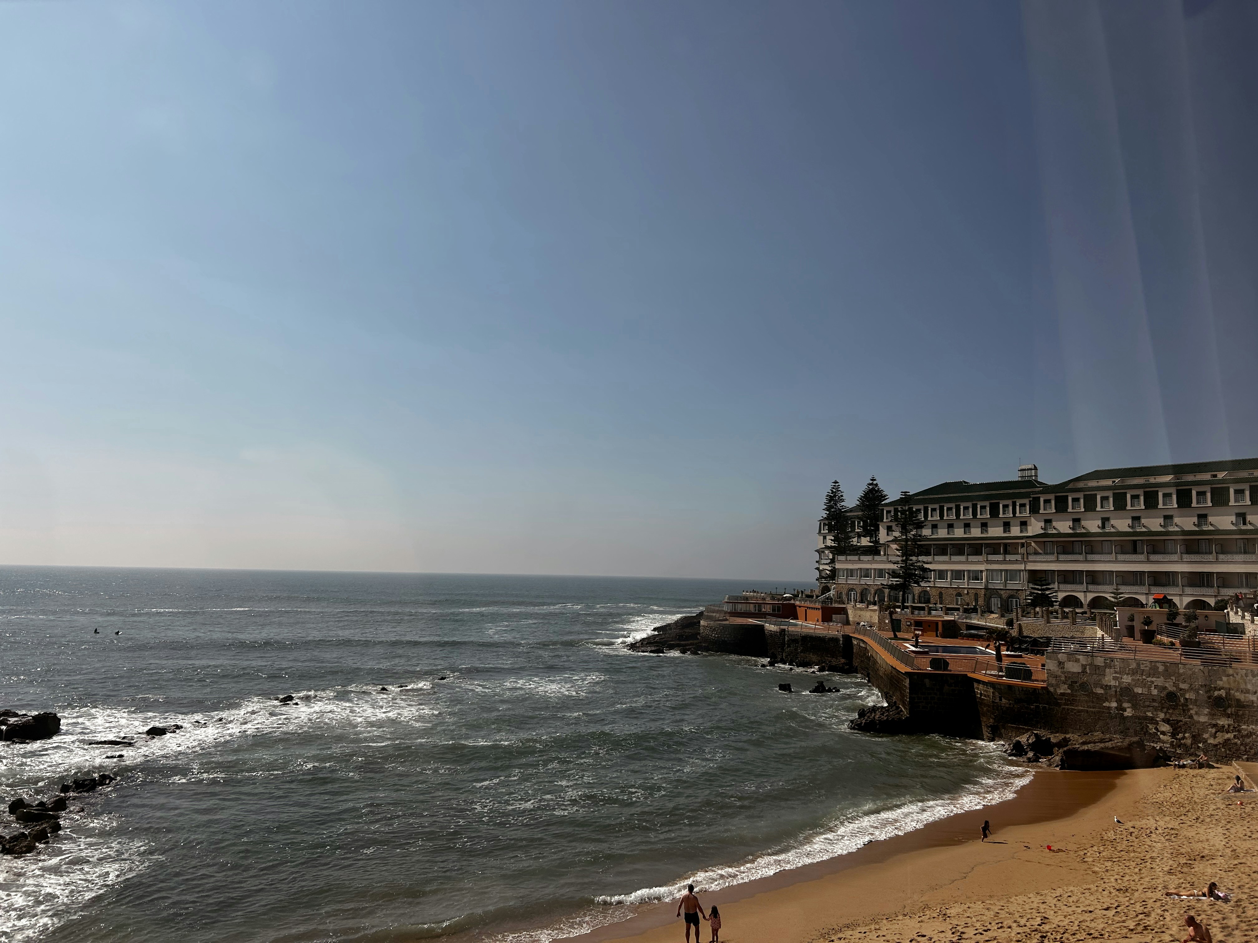 Coastal Terrace: Sunlit Sea and Historic Cliffs