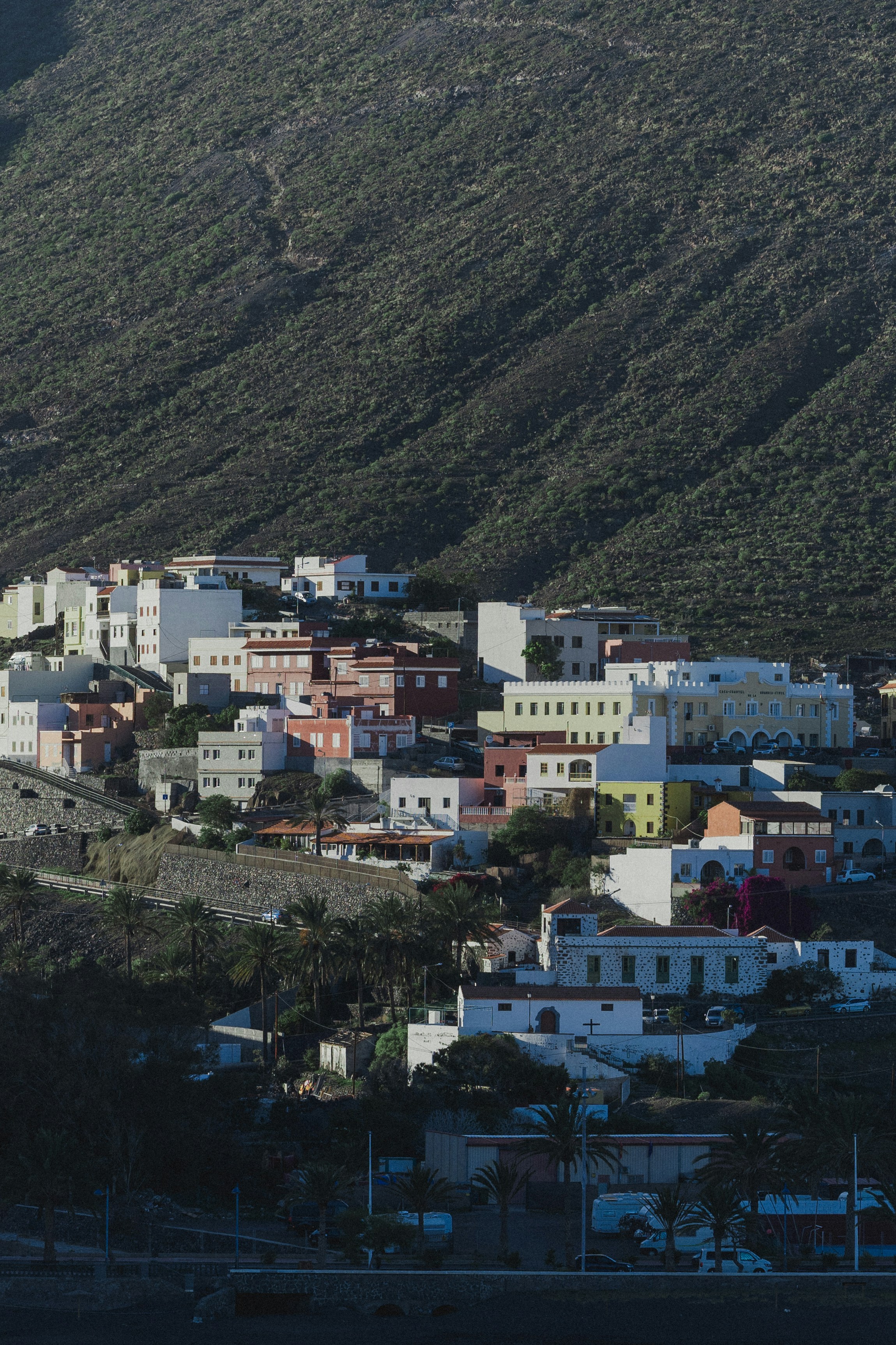 Pastel village tucked into a sunlit hillside