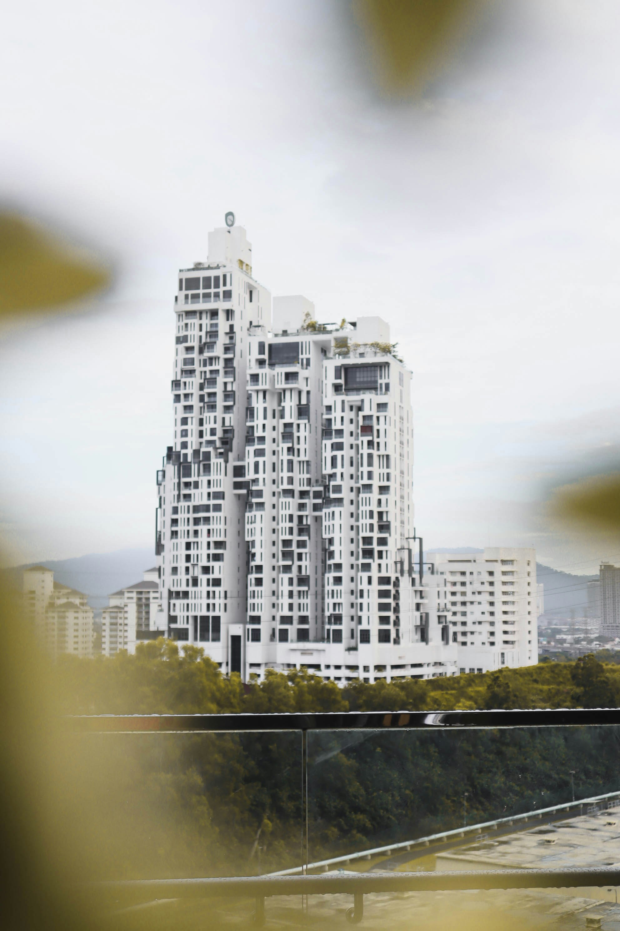 Towering Geometry: White Organs of Concrete Rise Above a Quiet Landscape