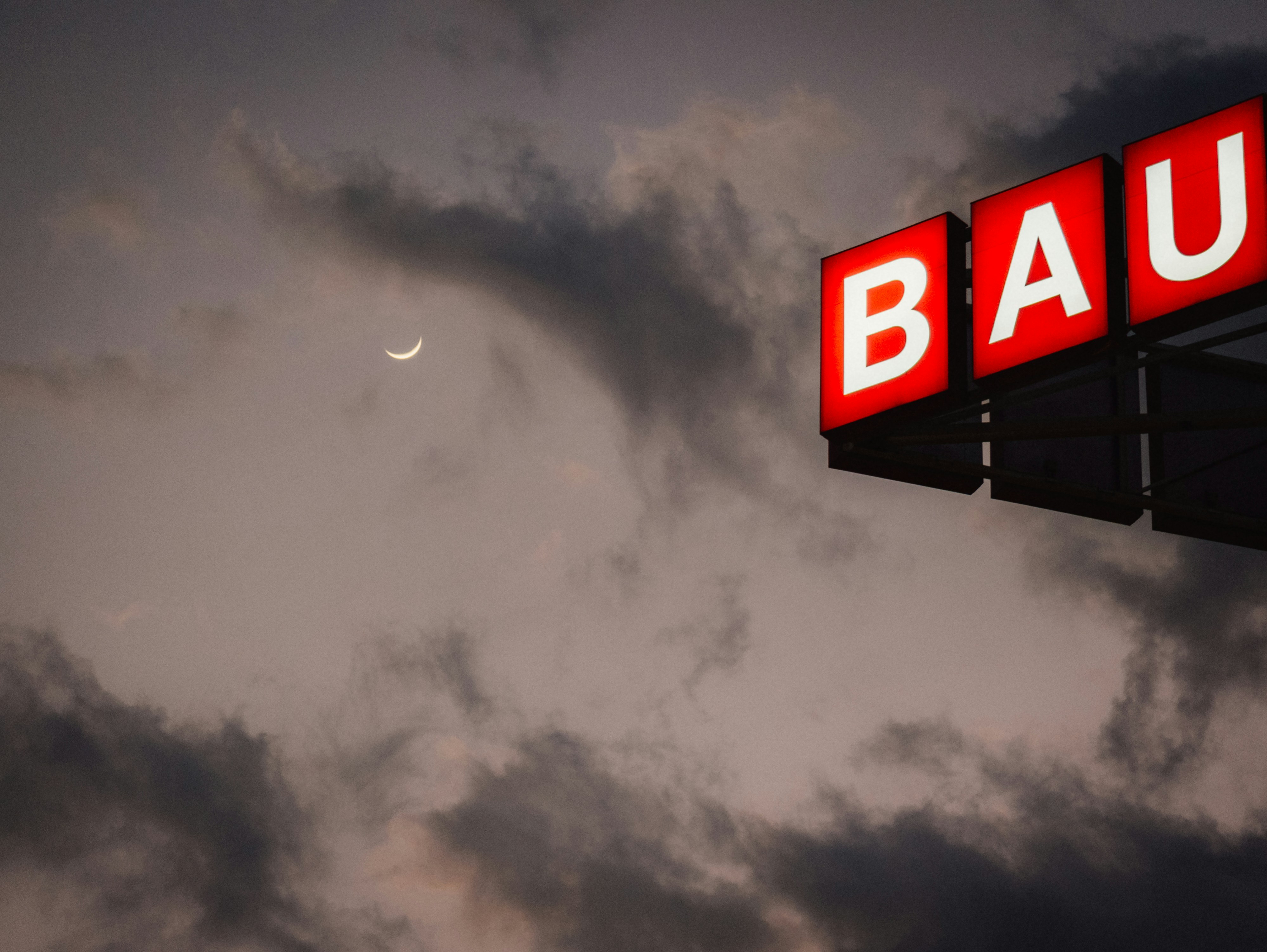 Crescent in the Neon Shadow: A BAU Sign on a Dusk Sky