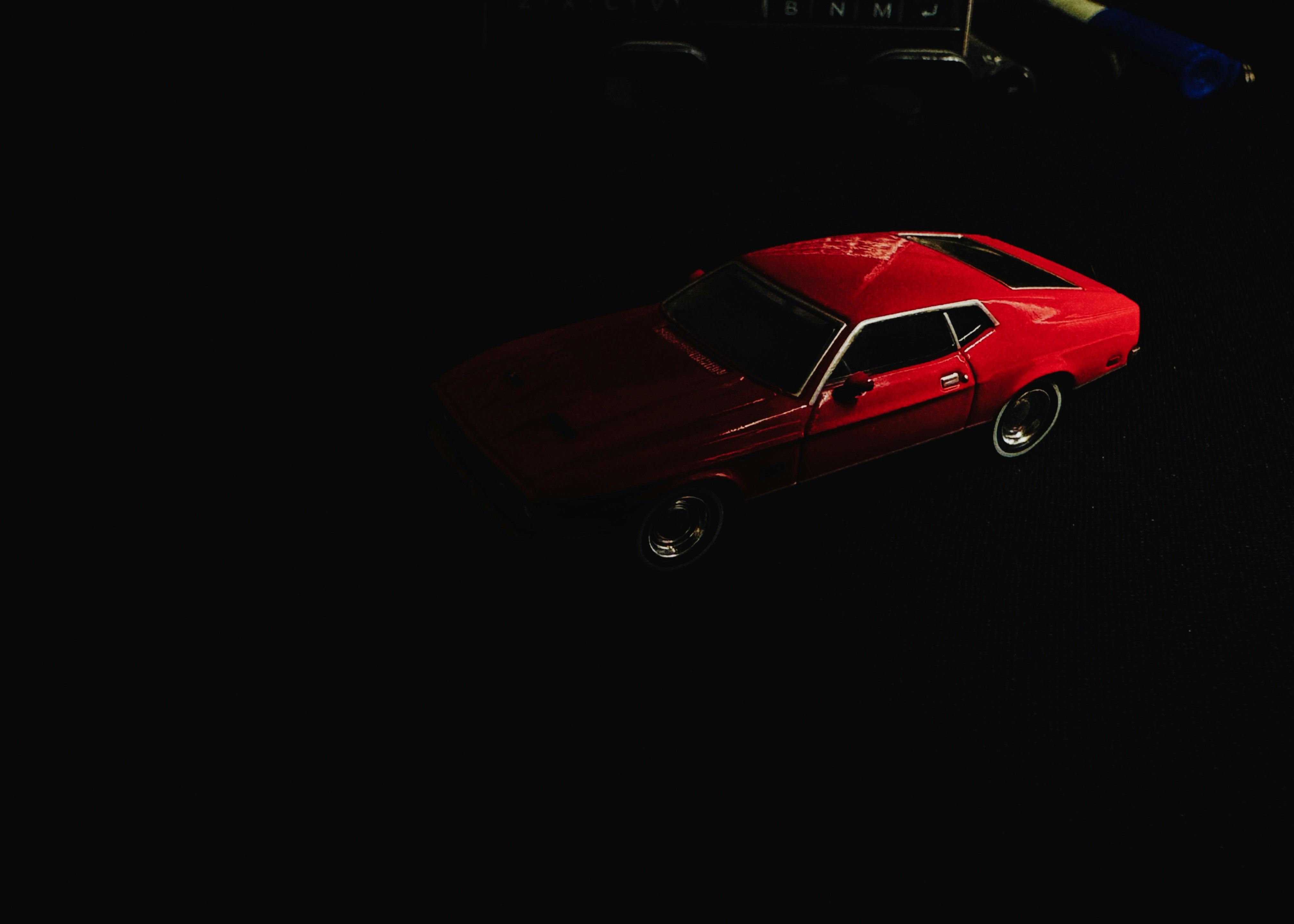 Red Muscle Car in a Velvet Darkness