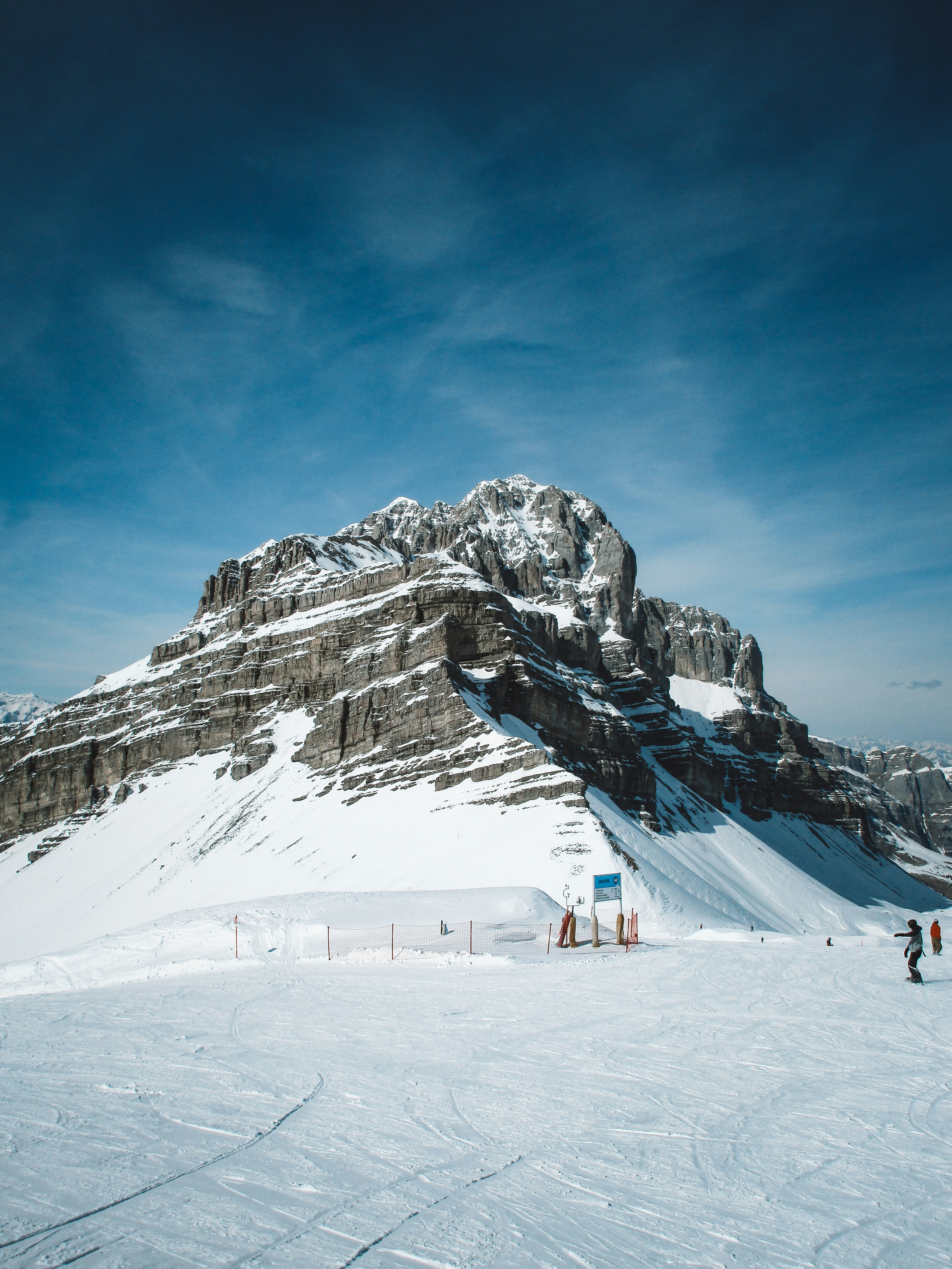 Snowbound Summit: A Lone Skier at the Foot of a Majestic Glacier Peak