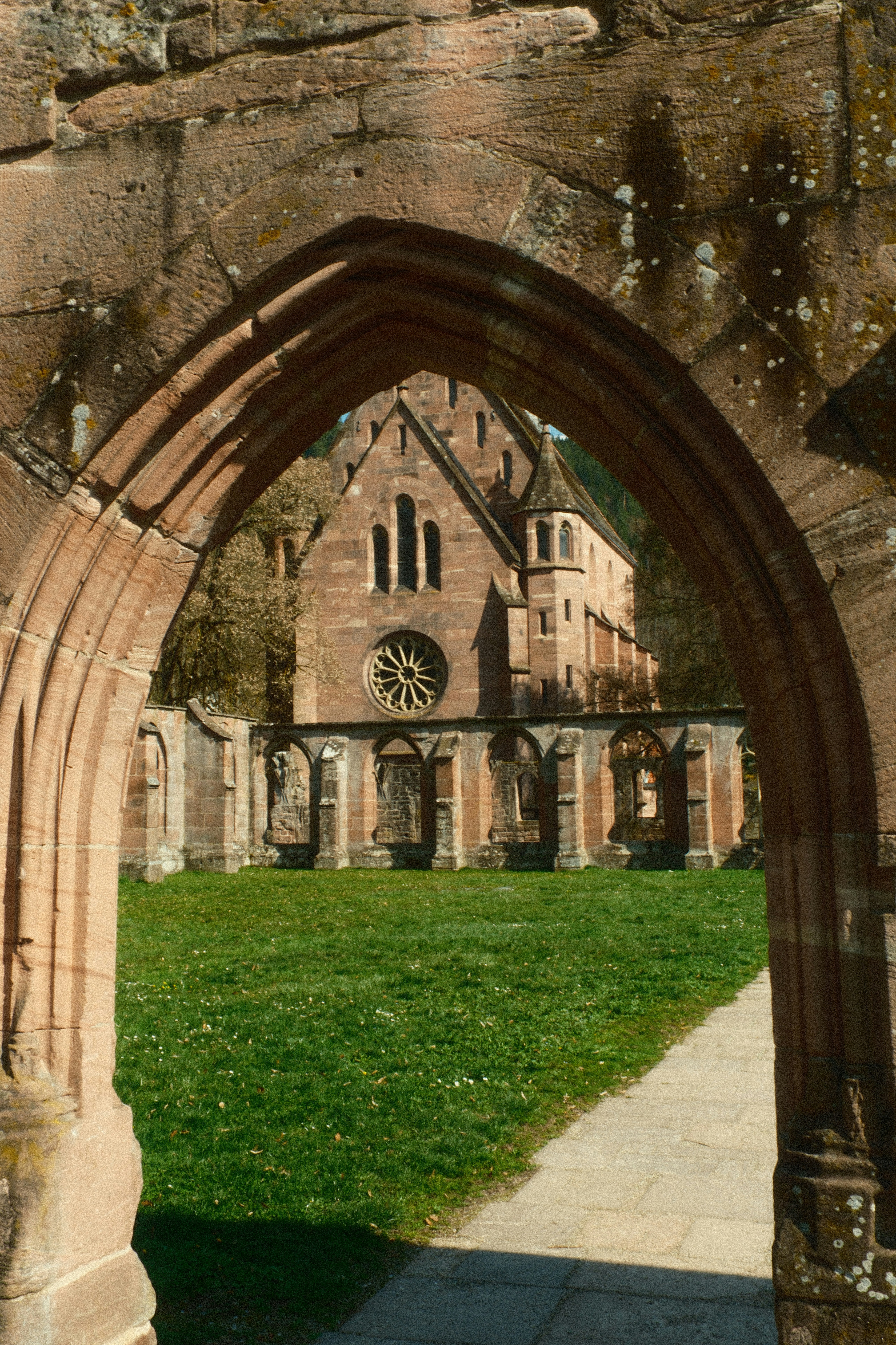 Stone Archway Framing a Ruined Abbey Landscape