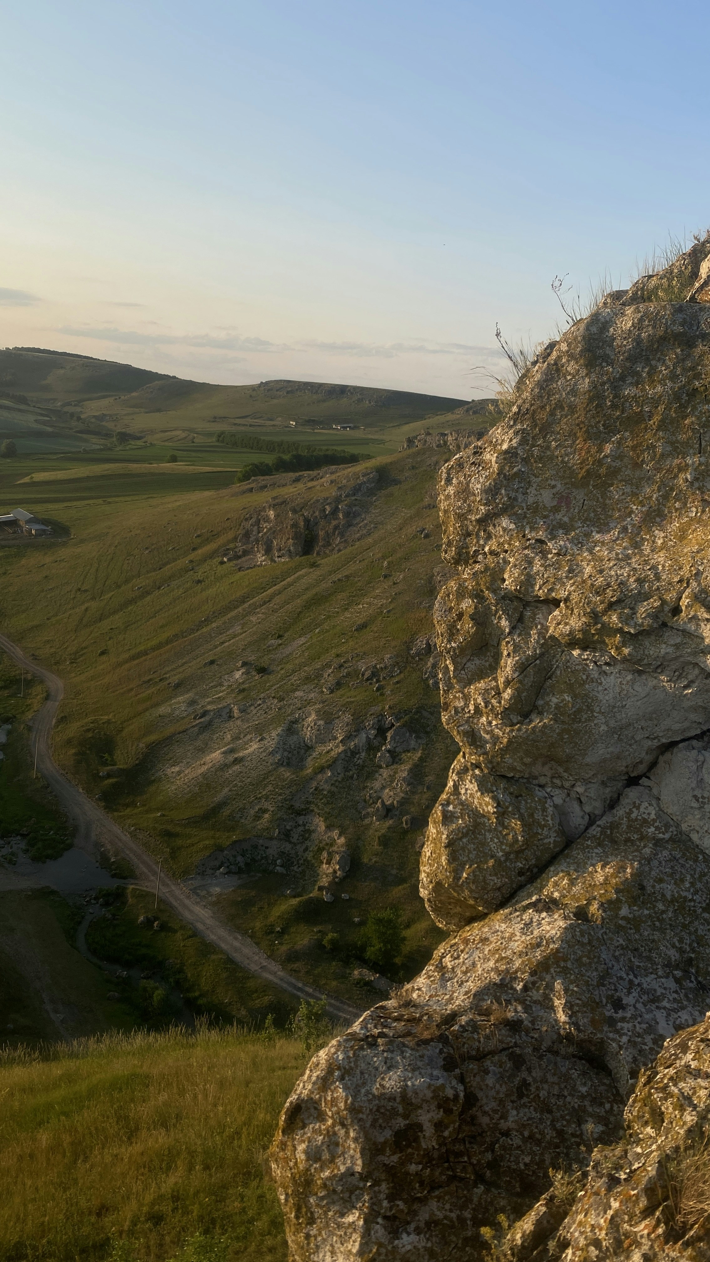 Rugged Cliffs at Dusk: A Vista Vanishing into Rolling Hills