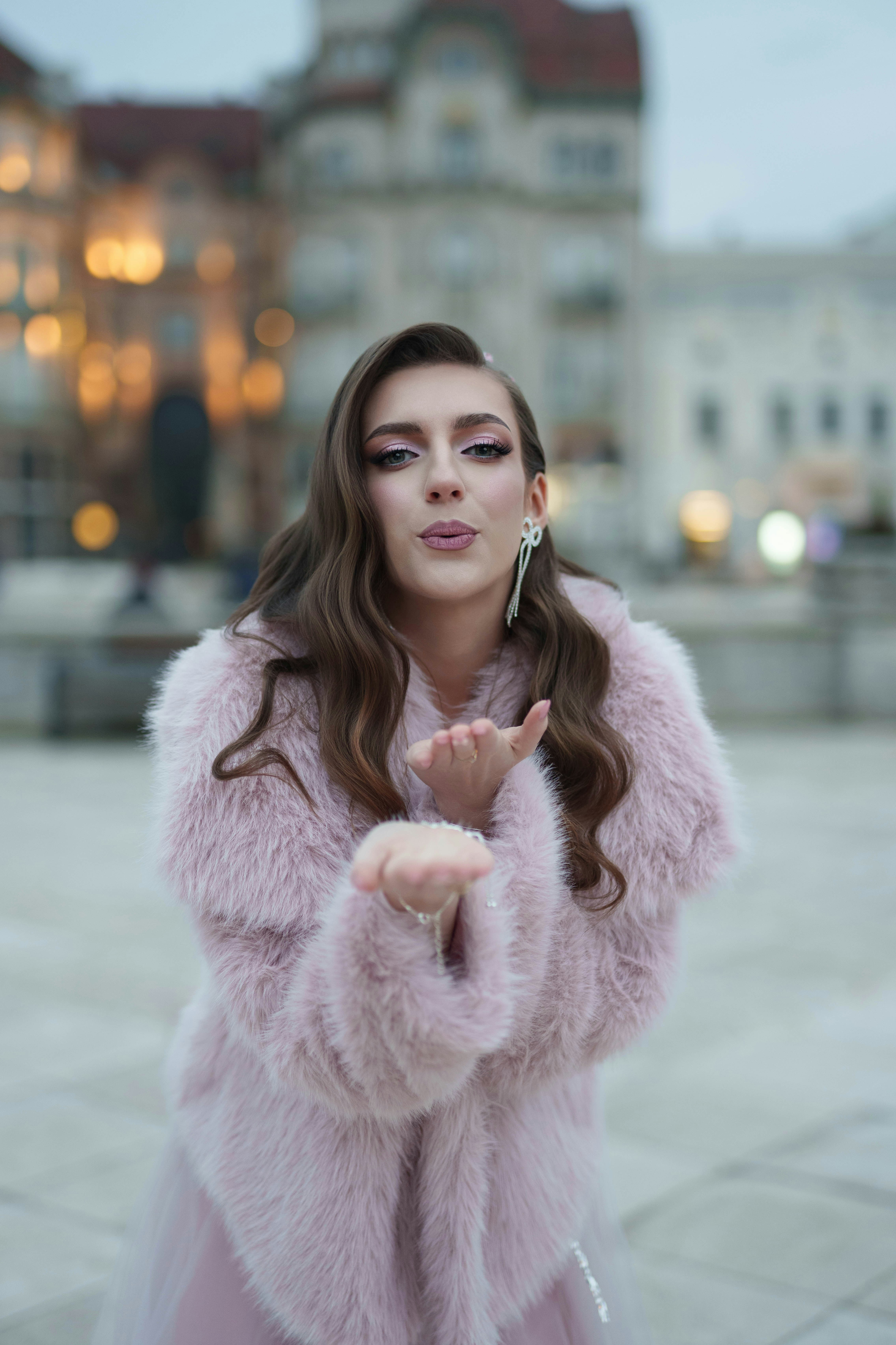 Blush Fur and Blown Kisses on a City Square