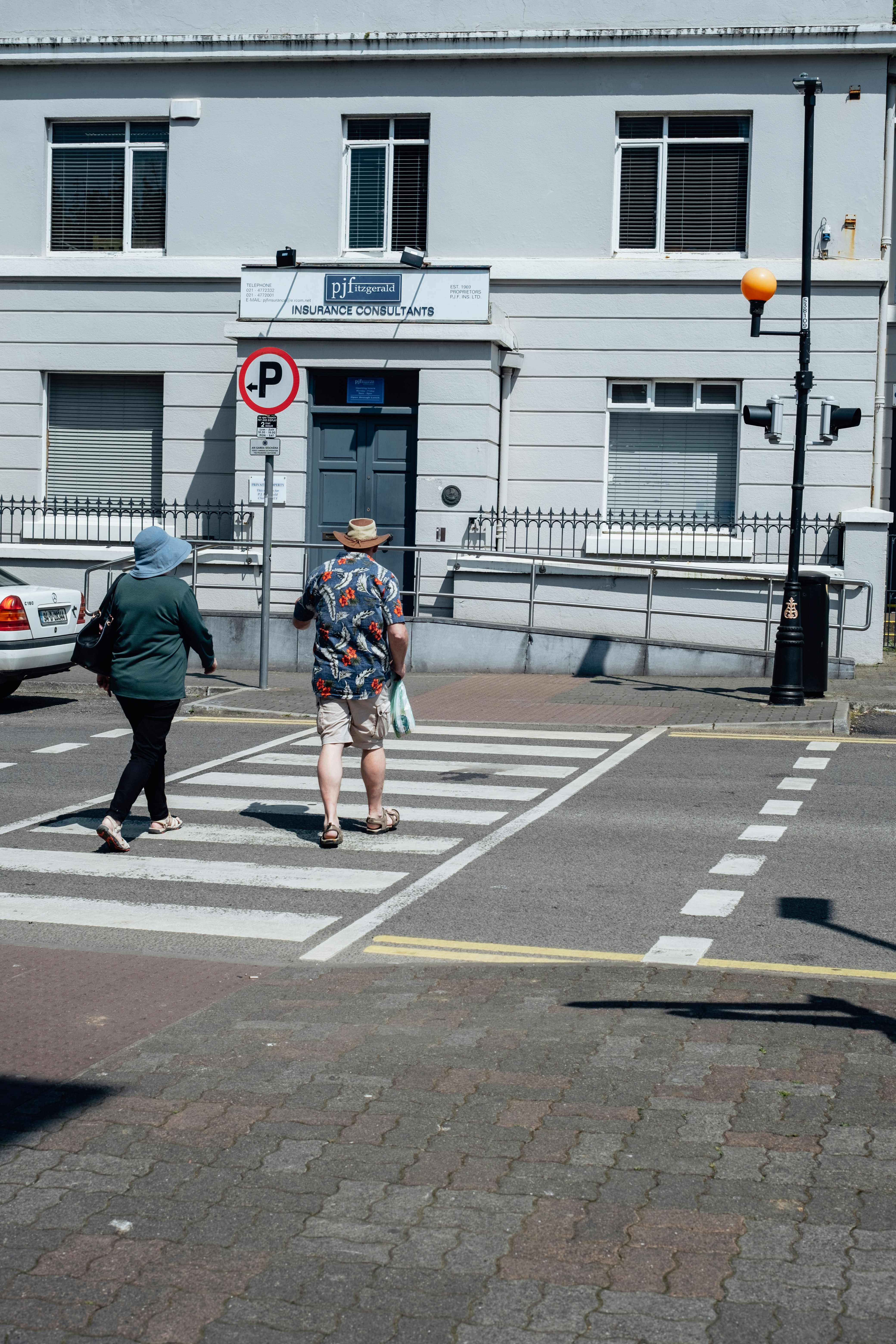 Crosswalk Conversations: A Street Crossing in Front of a Corporate Facade