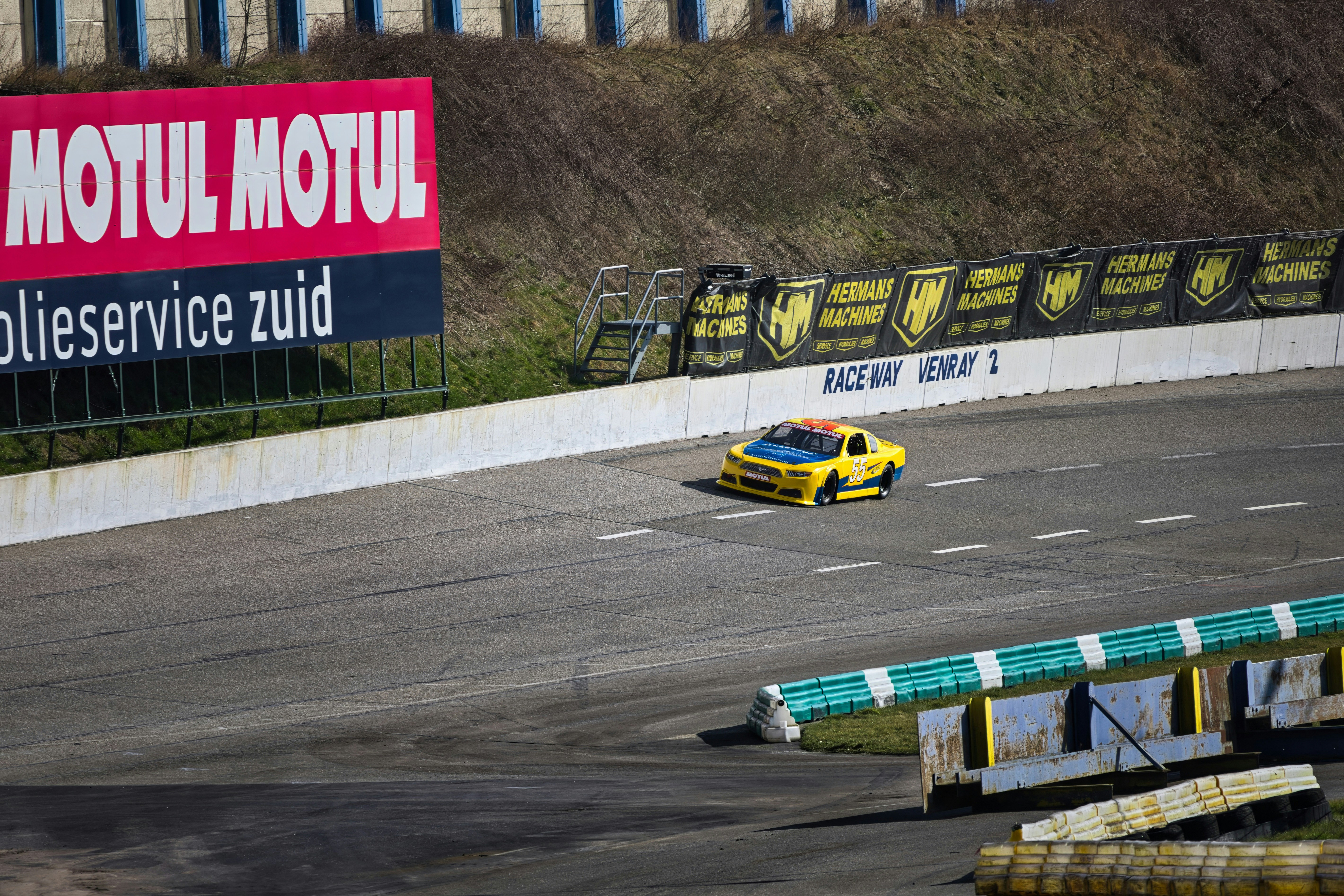 Yellow Race Car on Banked Track Bends the Horizon