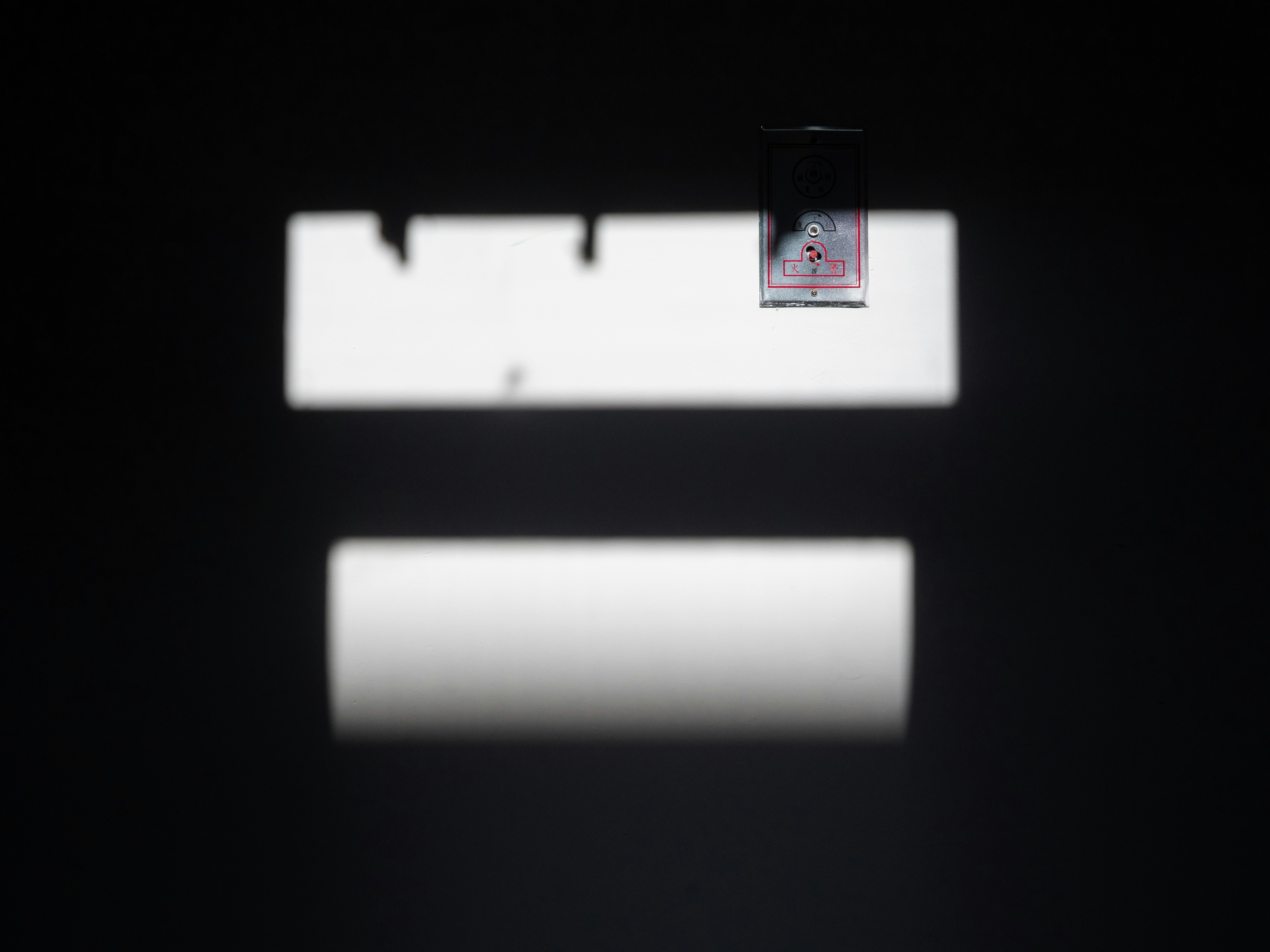 Shaded Gap: A Quiet Window Scene with a Hanging Tag