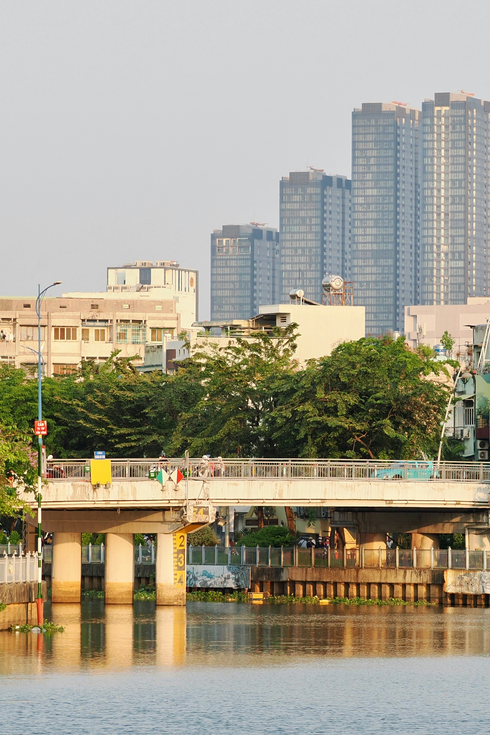 Urban Riverwalk Beneath Towering Cityscape