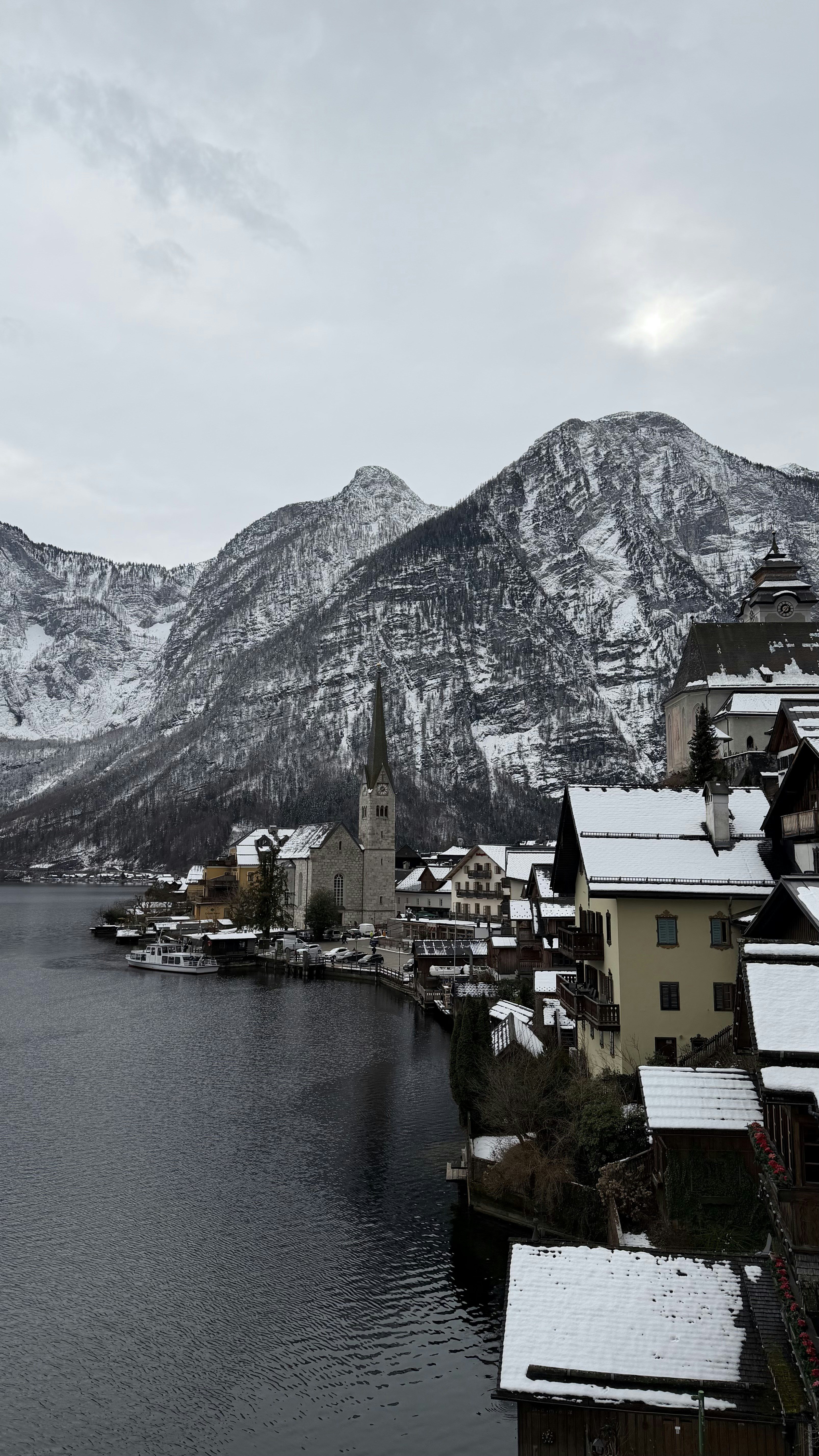 Snowbound Village by the Lake Under Jagged Peaks
