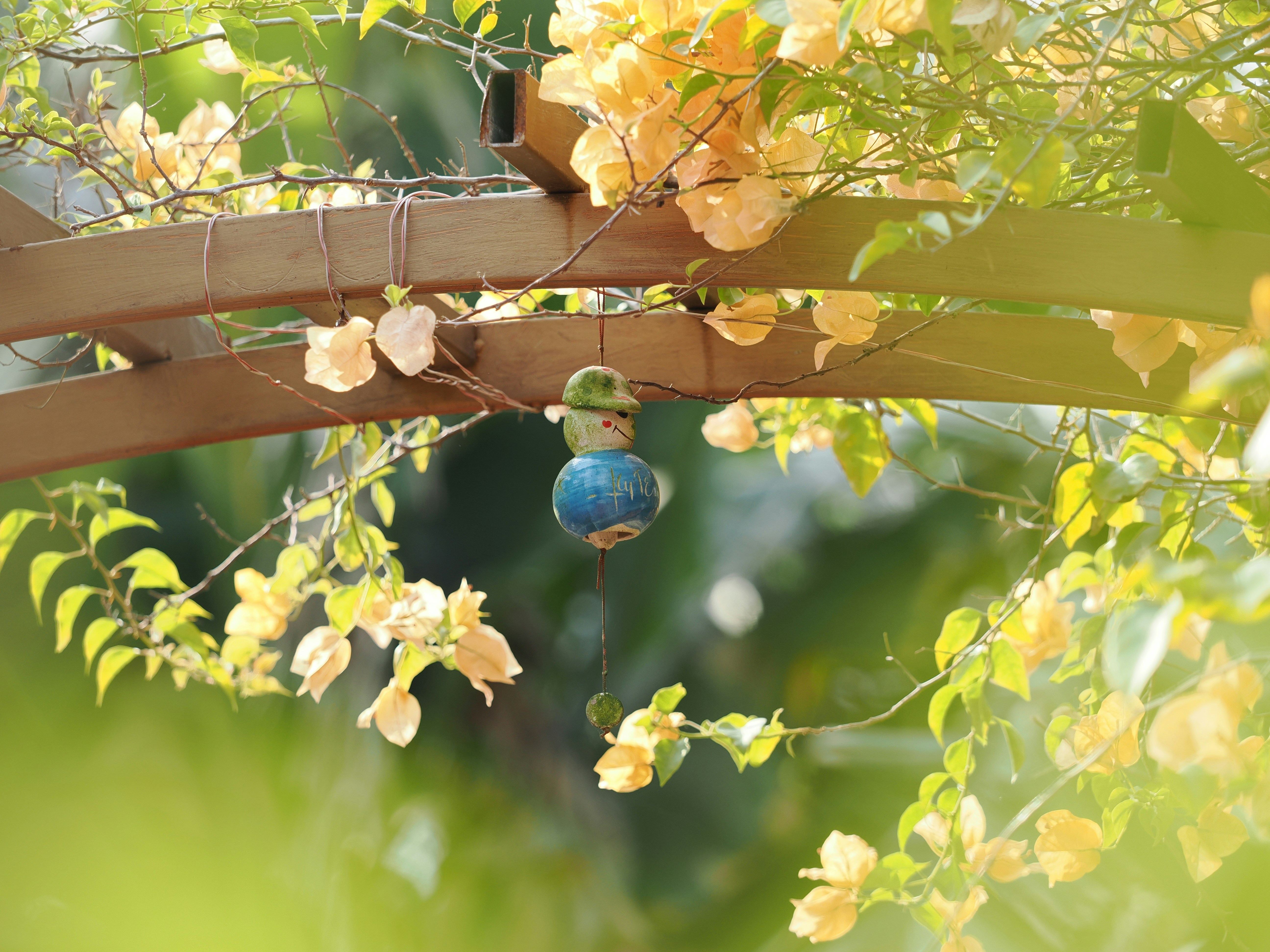 Floating Globe Ornament Under Warm Autumn Blooms
