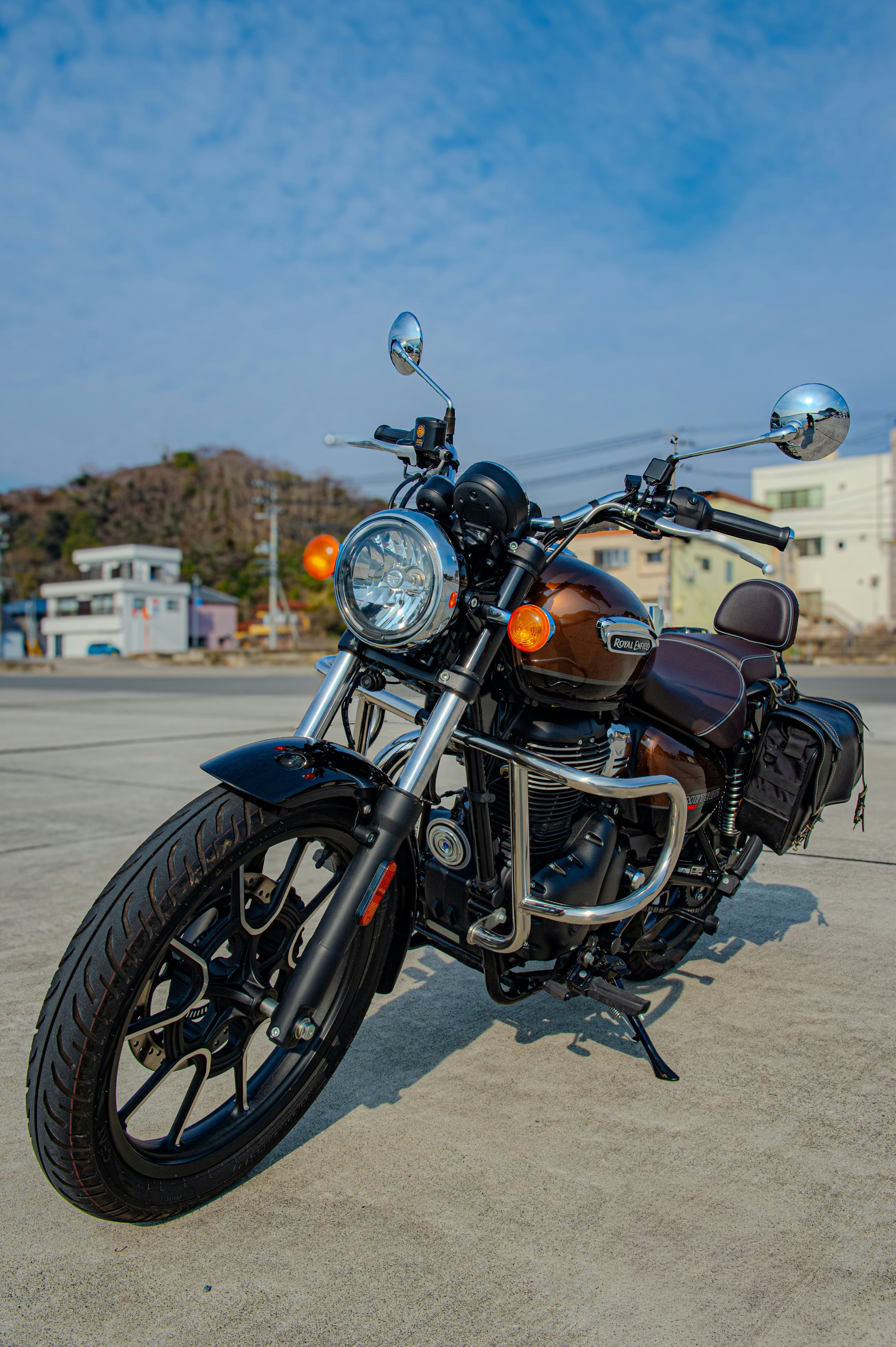 Chrome and Copper: A Classic Motorcycle Resting Under a Clear Blue Arc