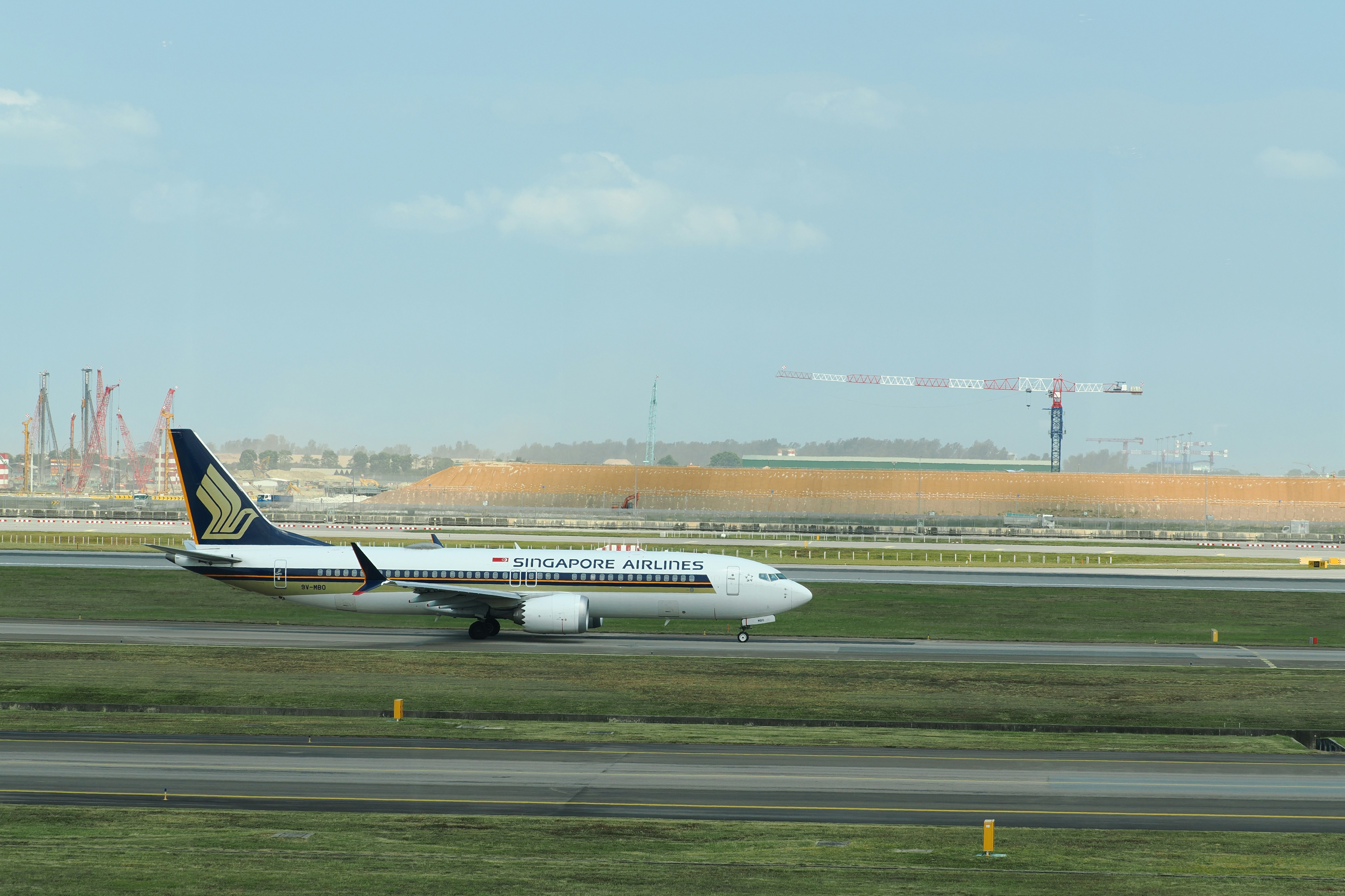 Taxiing Singapore Airlines Boeing on a sunlit runway