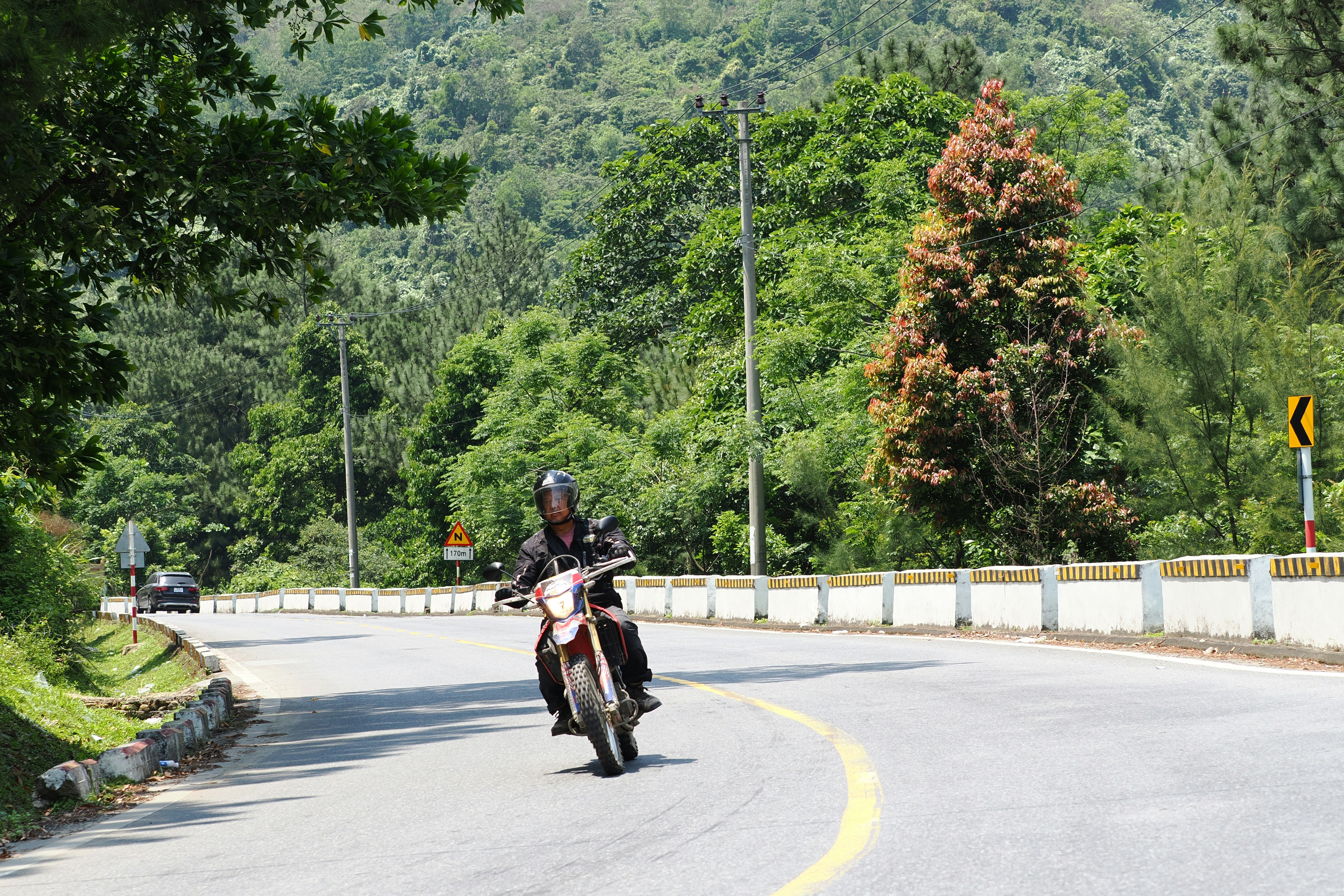 Curve and Rider: A Motorbike Rounds a Mountain Pass