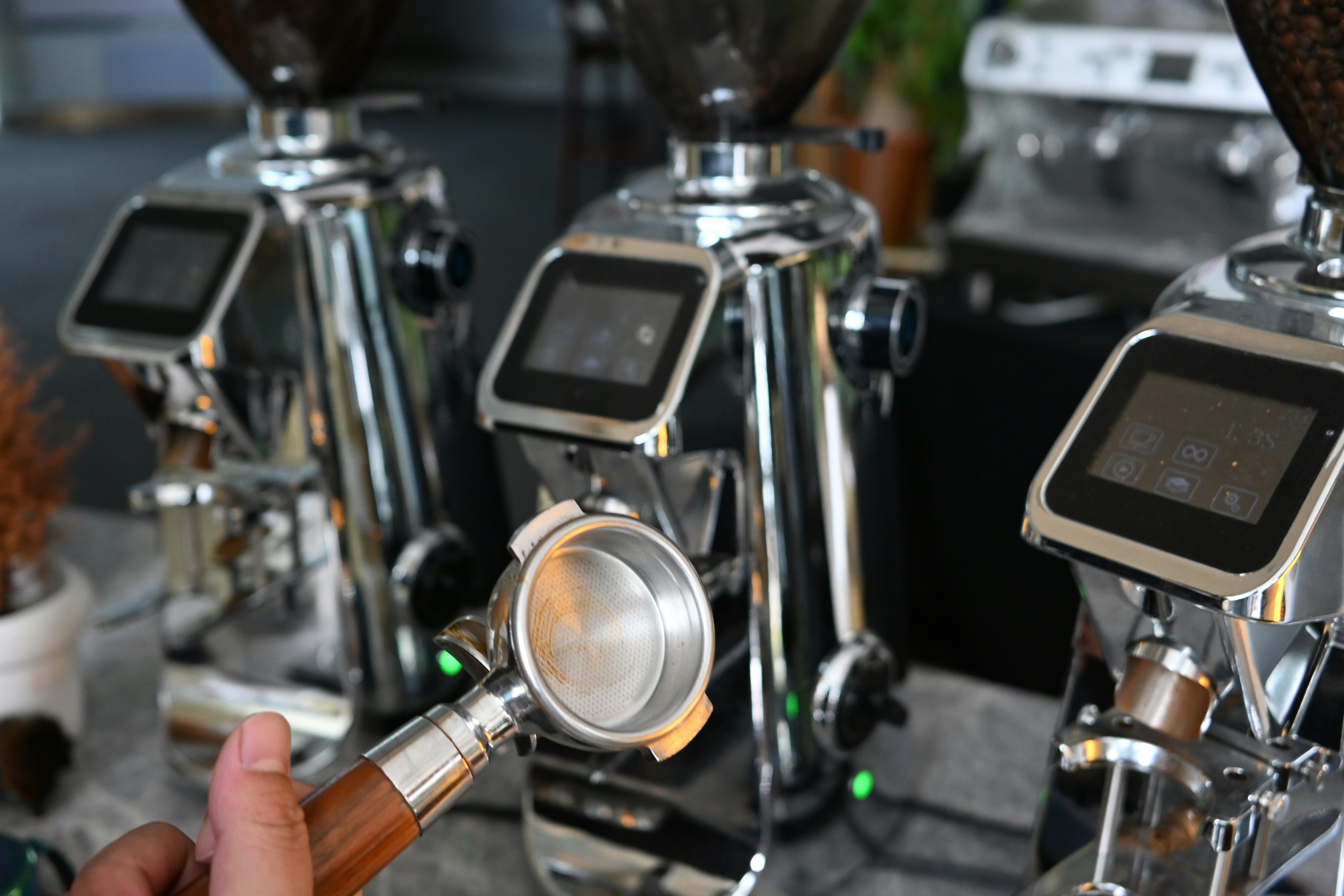 Barista’s Hand Steams a Fresh Espresso Shot in a Row of Espresso Machines