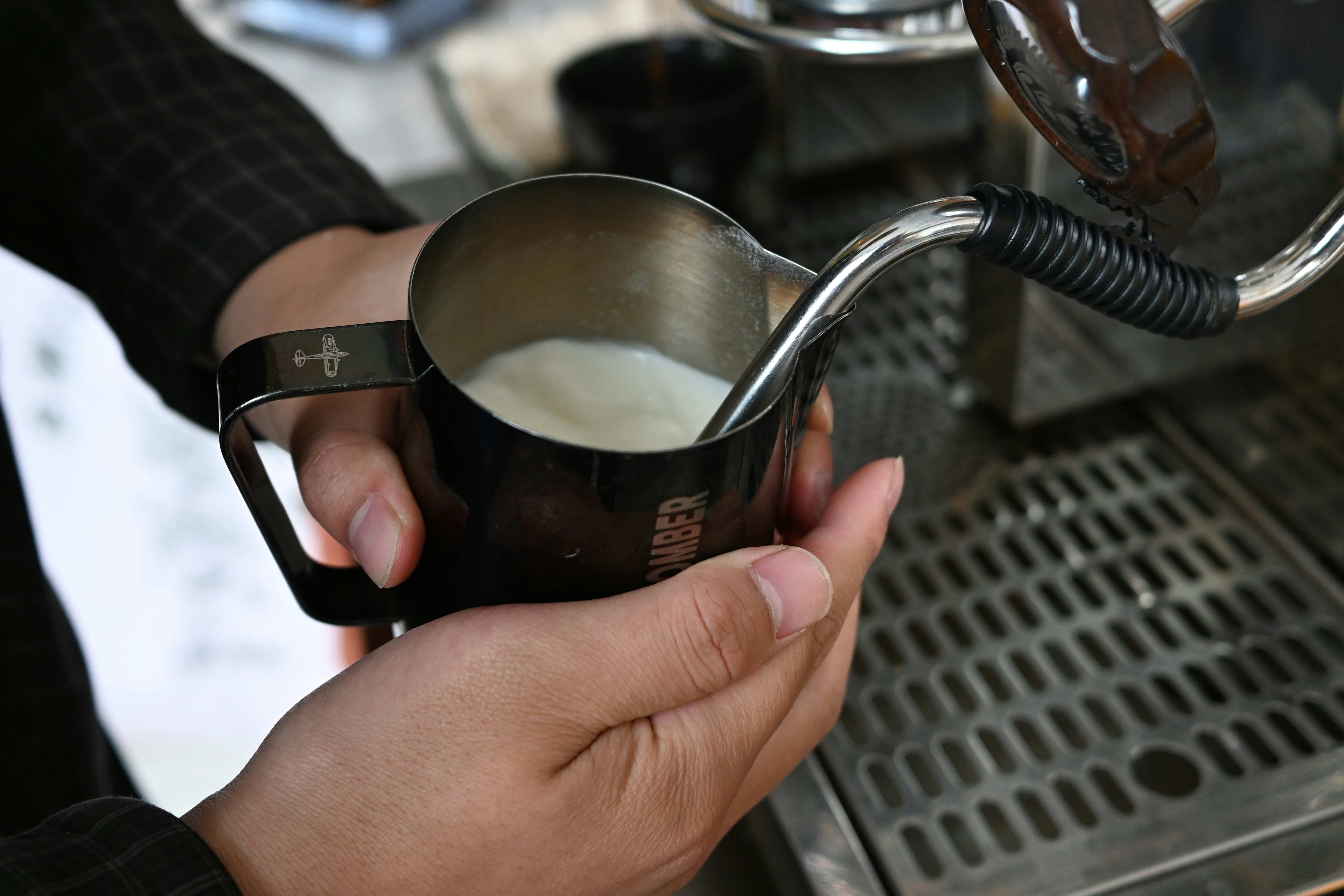 Foamy Pour Over: Barista Hands Nestle a Copper Pitcher