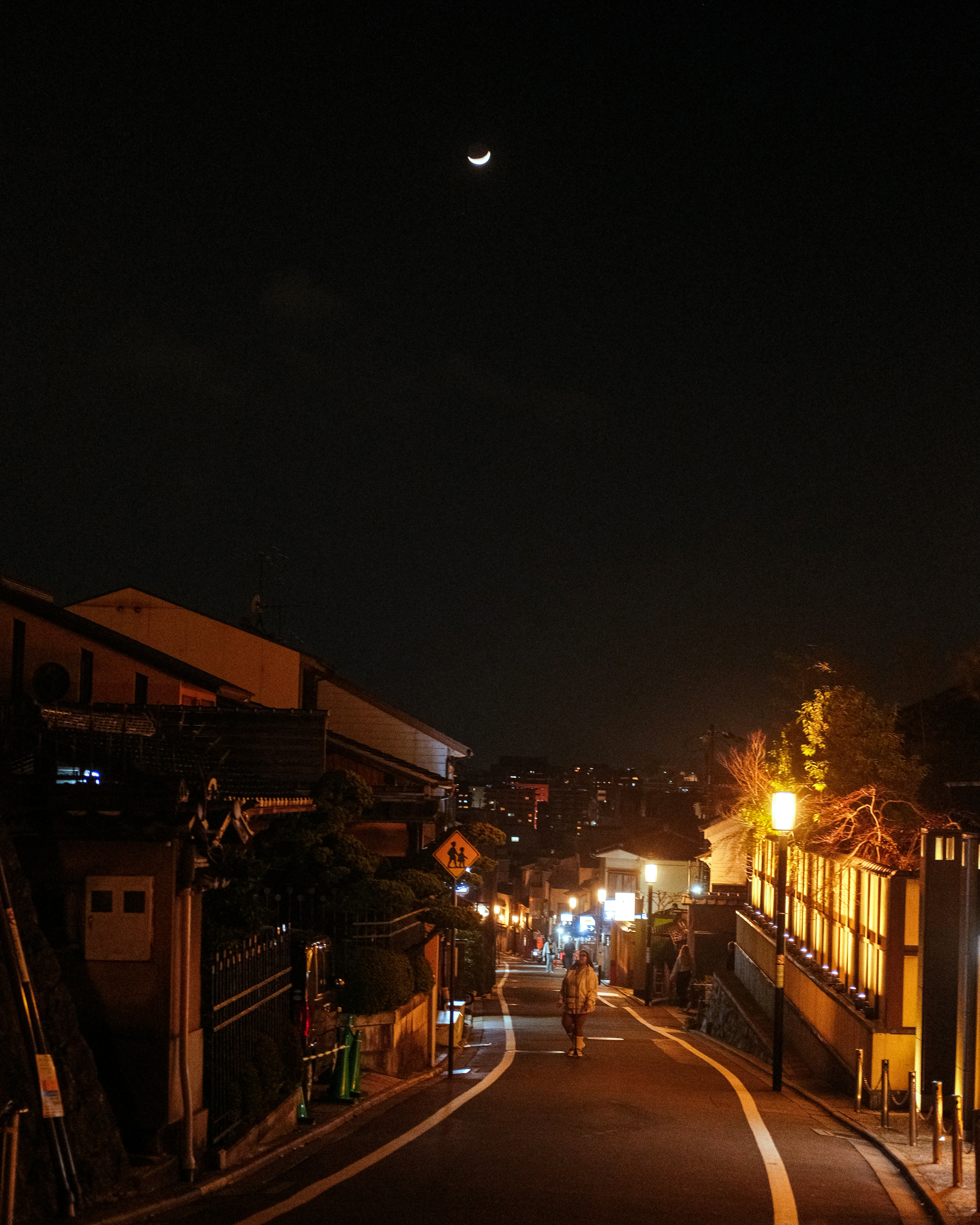 Night Street Descent: A Quiet Walk Beneath a Crescent Moon