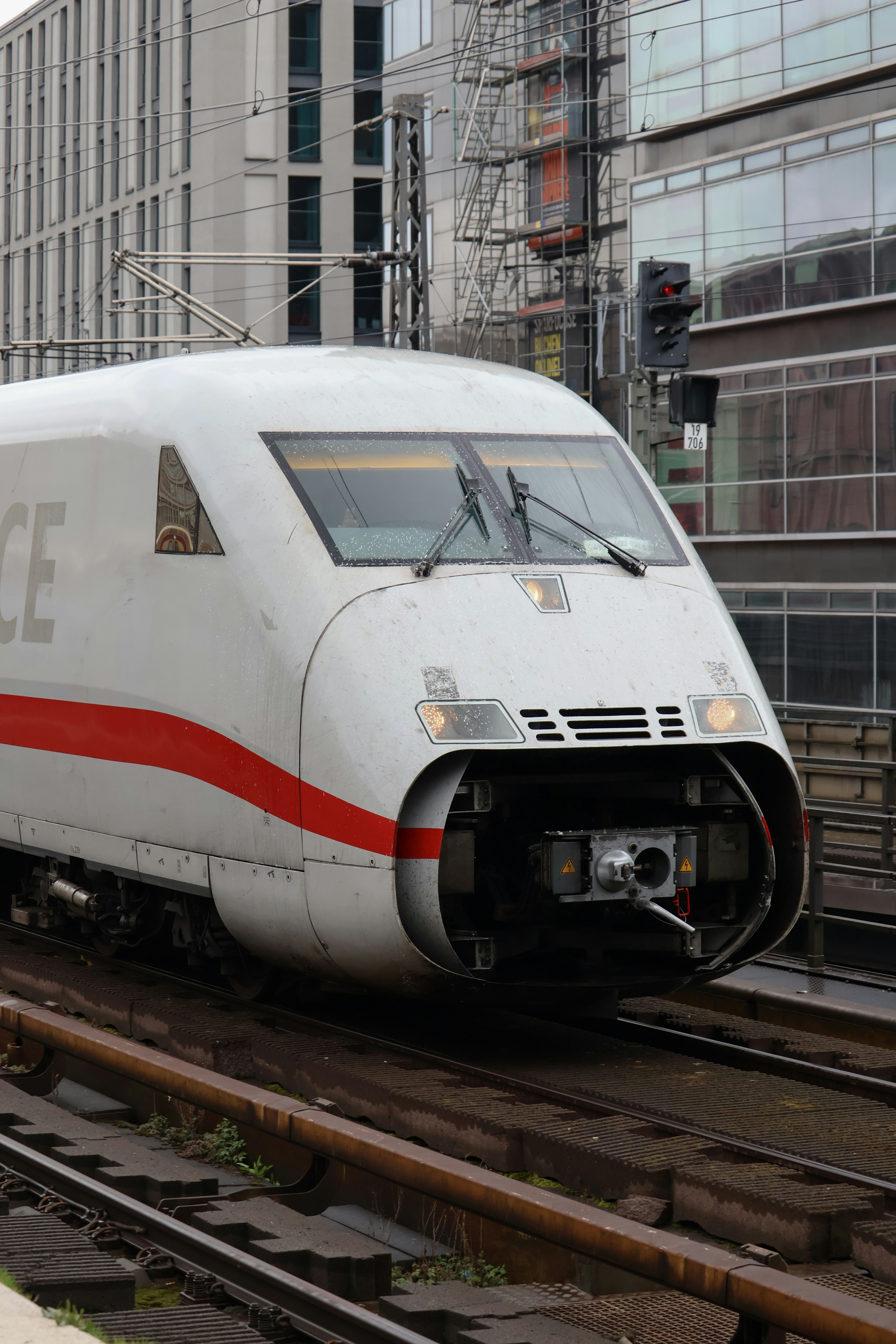 White Arrow: A streamlined train carving through an urban canyon