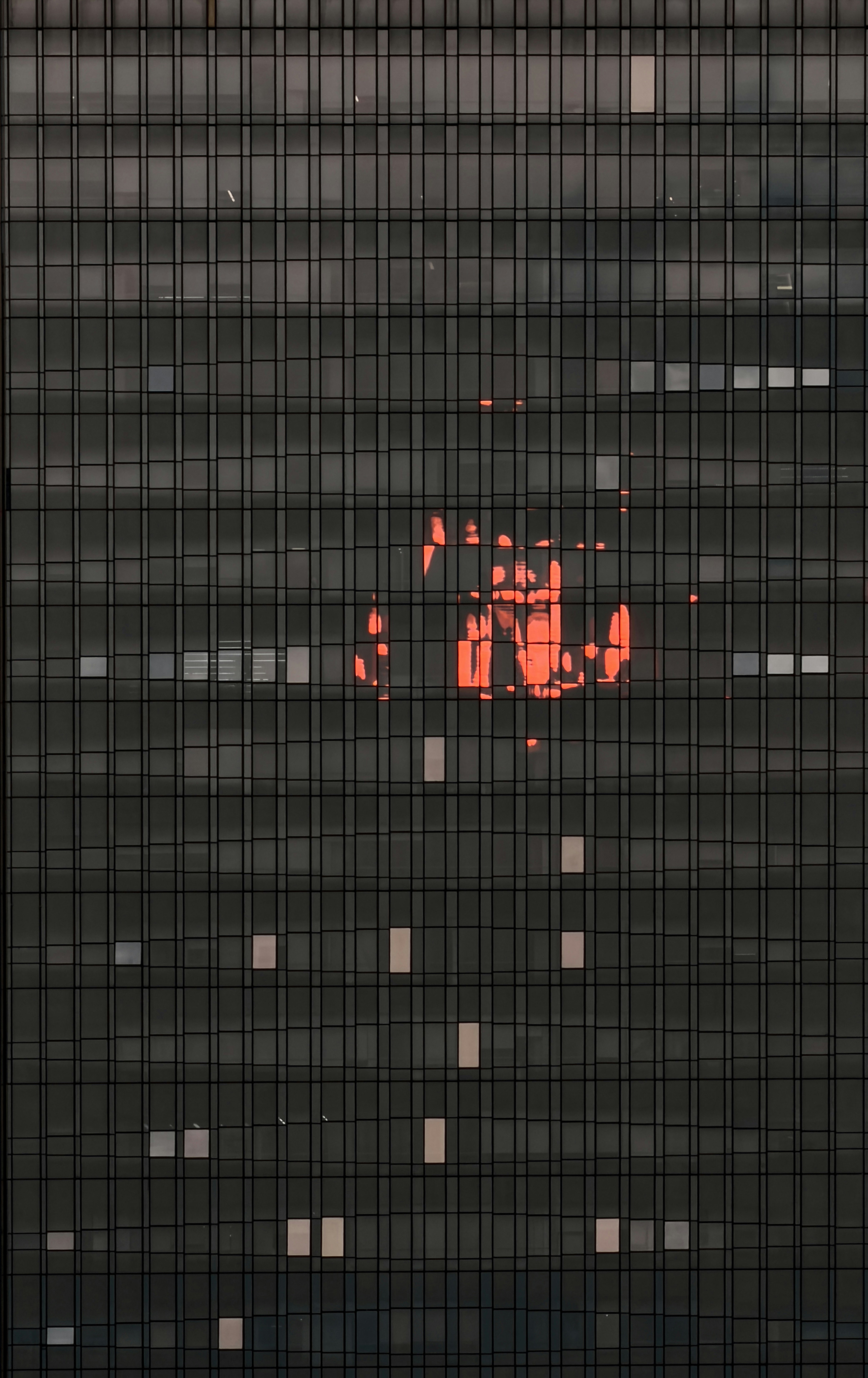 Red Neon Emblem Fragmented Across a Windows Grid