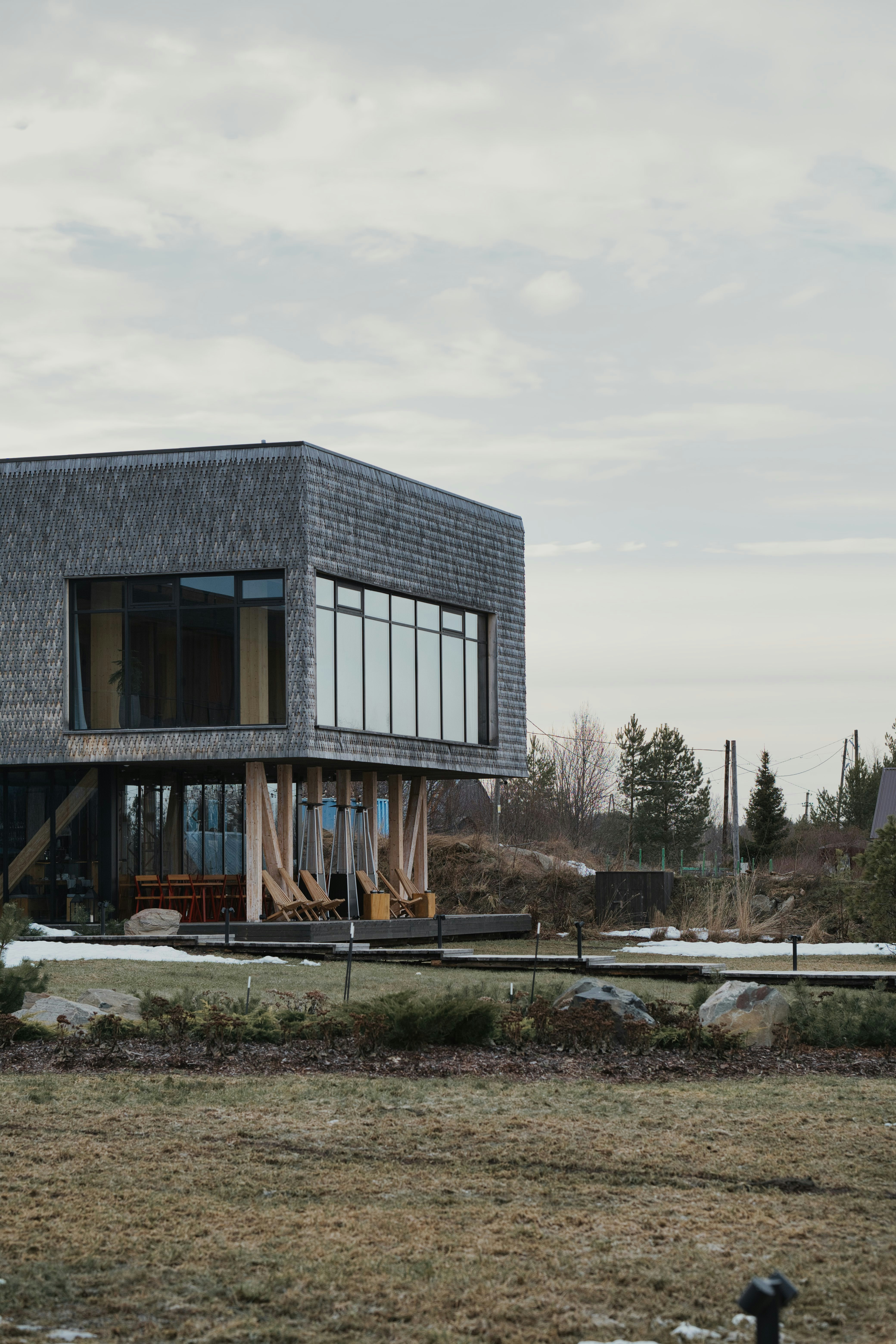 Modern hillside villa under construction with timber scaffolding