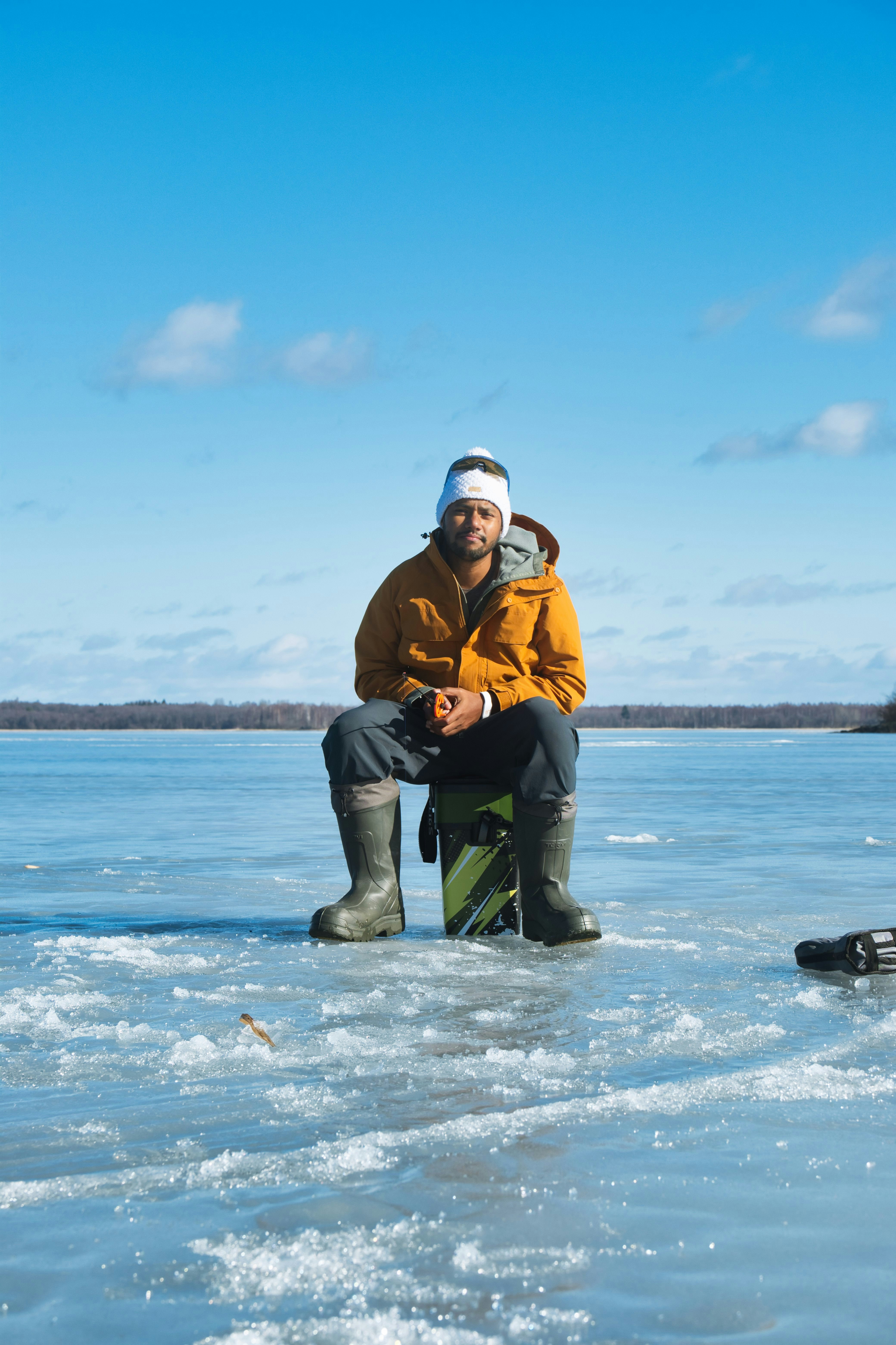Icebound Gaze: Fisherman in Bright Winter Light