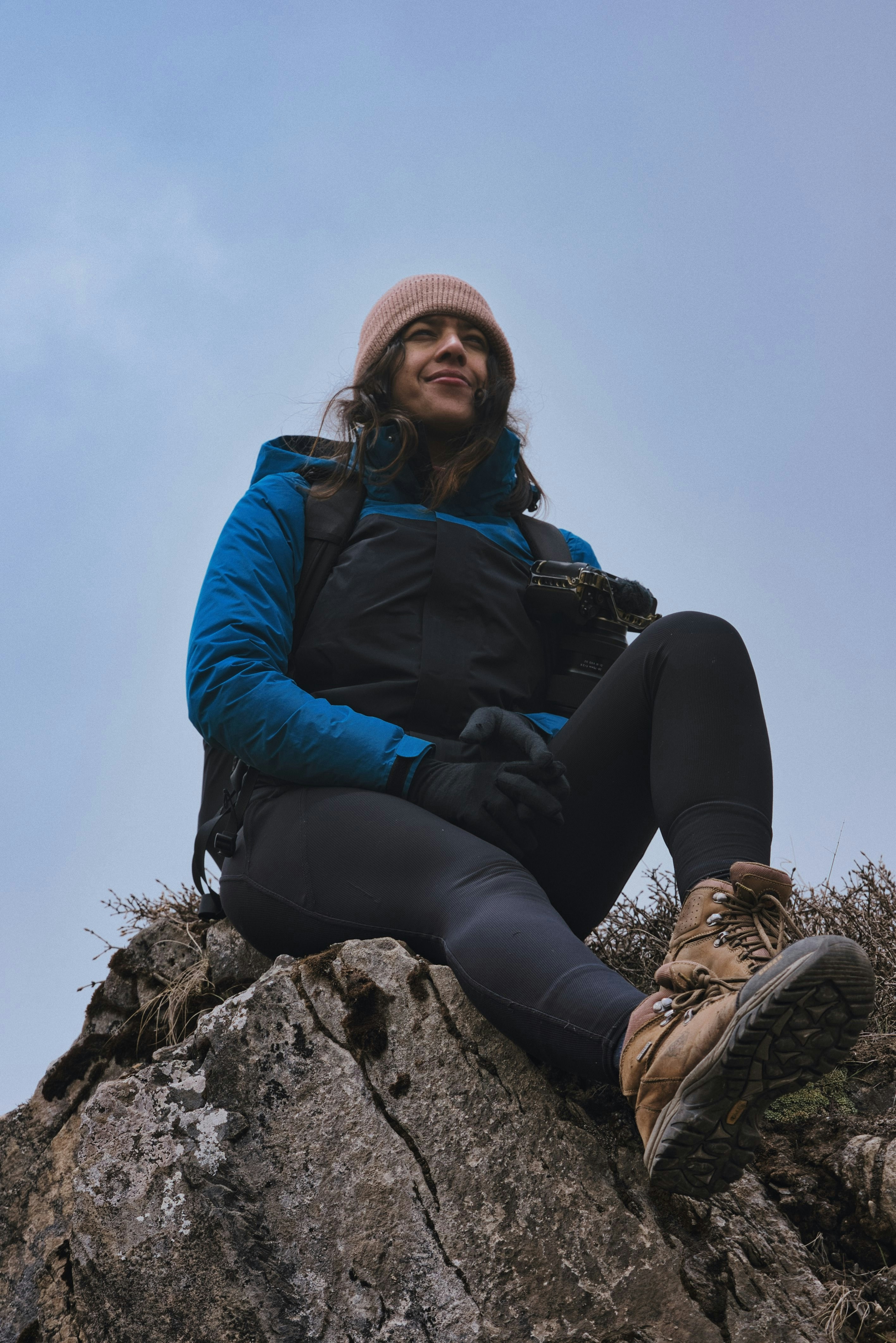 Grounded in Adventure: A climber atop rugged stone