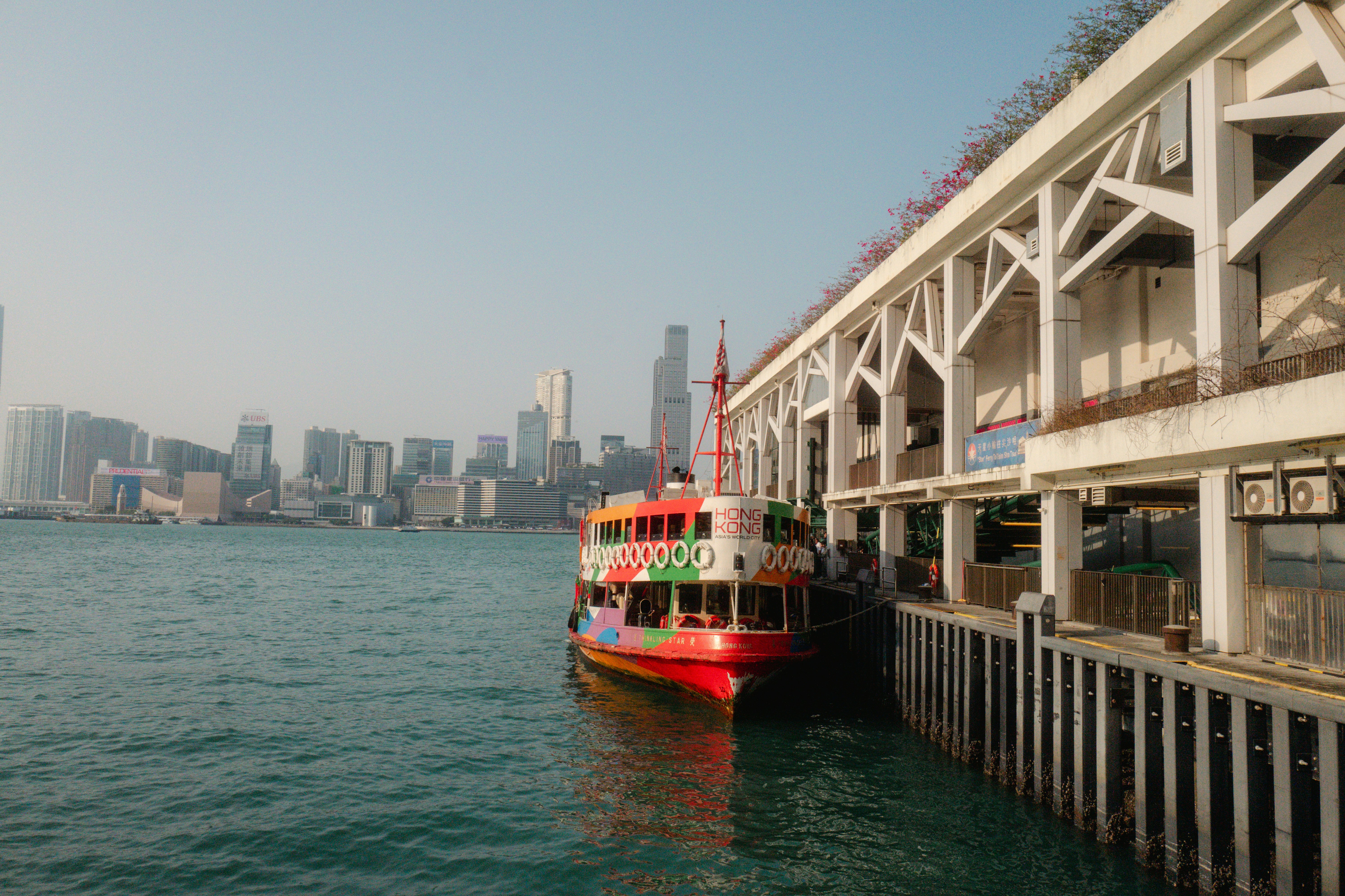 Red Boat at the Ferry Pier: A City Skyline Rendezvous