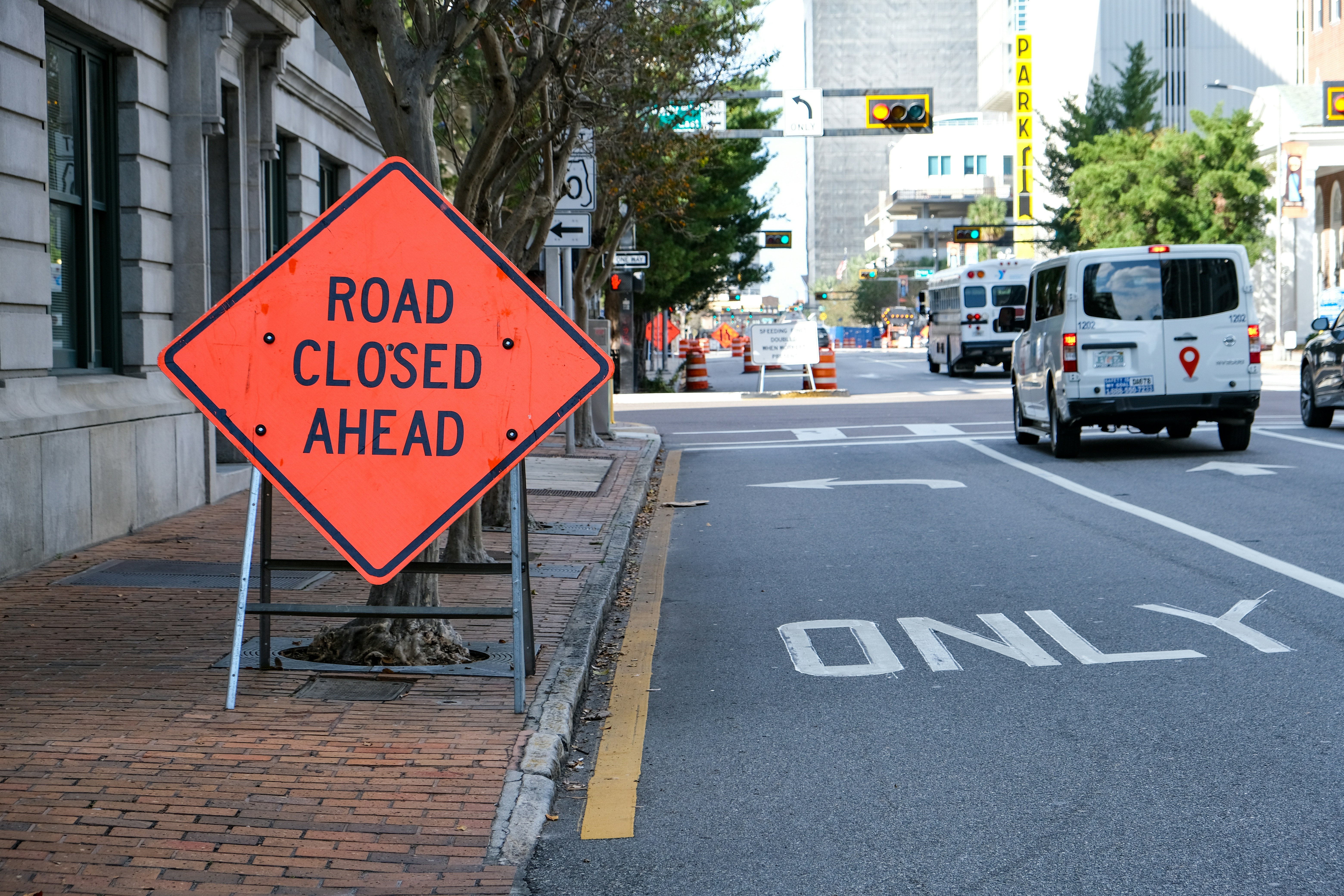 Orange Road Sign Forefront: A City Street Under Construction