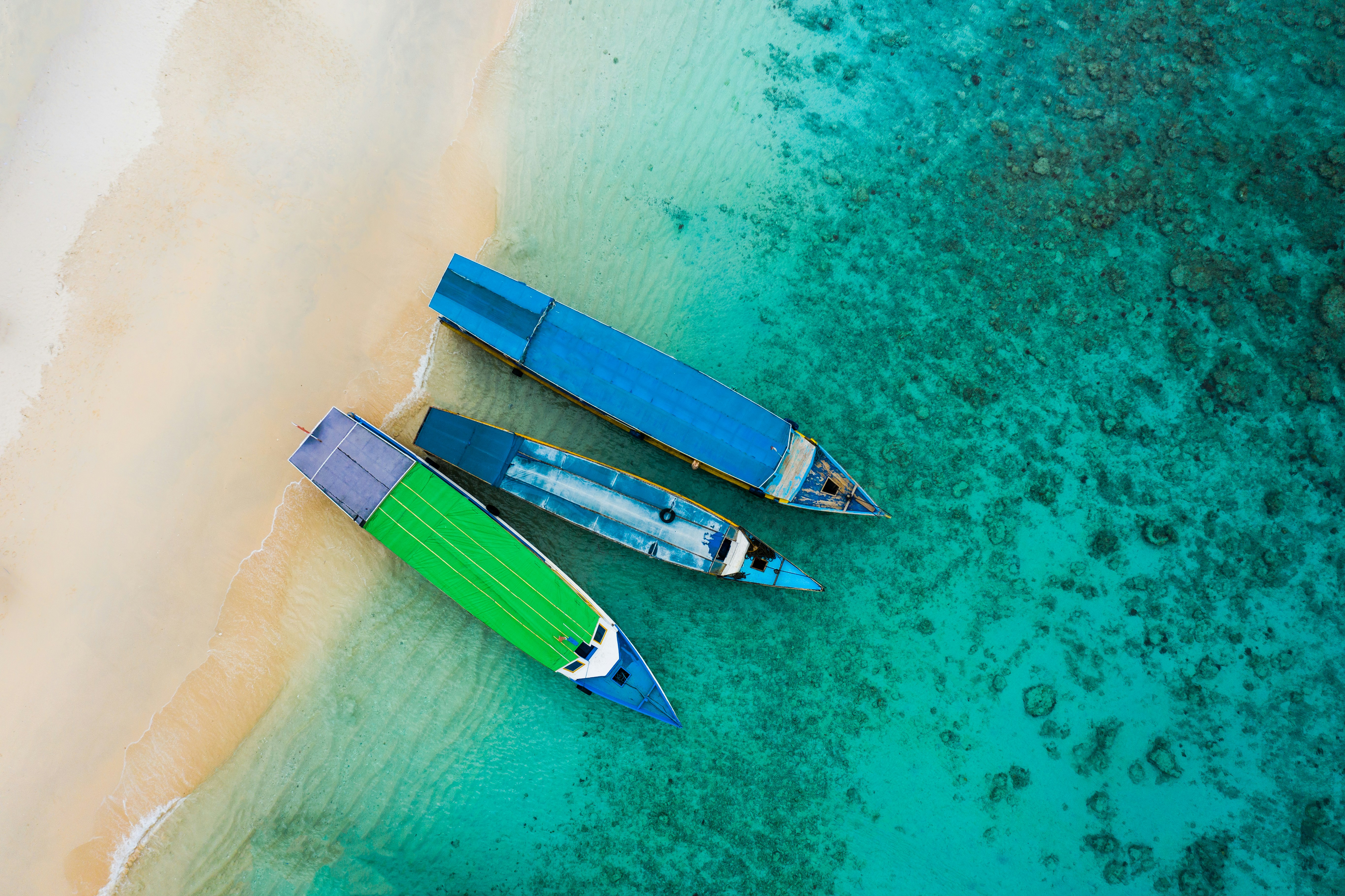Triad of Color: Boats Resting on Caribbean Cyan