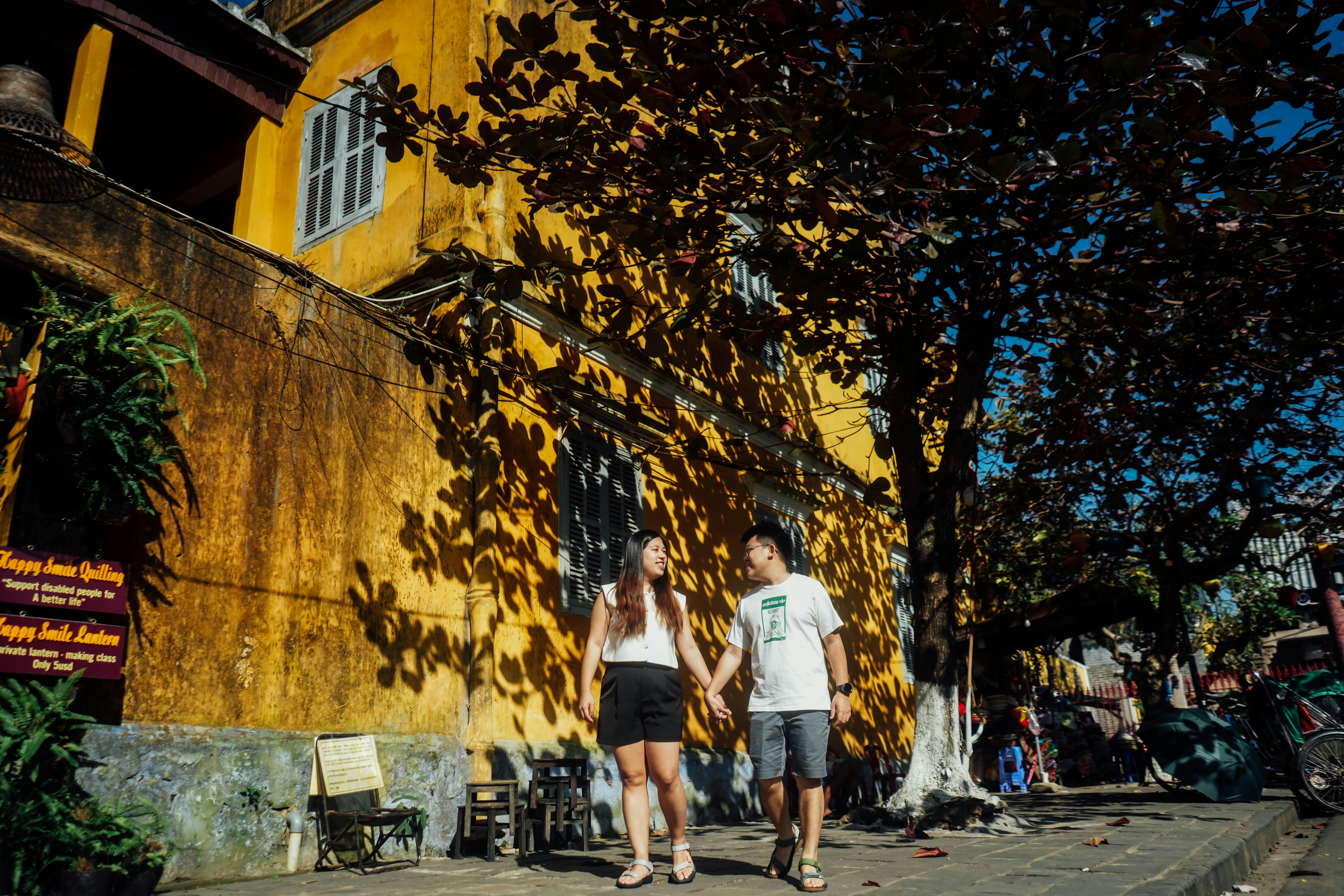 Sunlit Yellow Street Duo: A Quiet Moment Near the Old Town Wall
