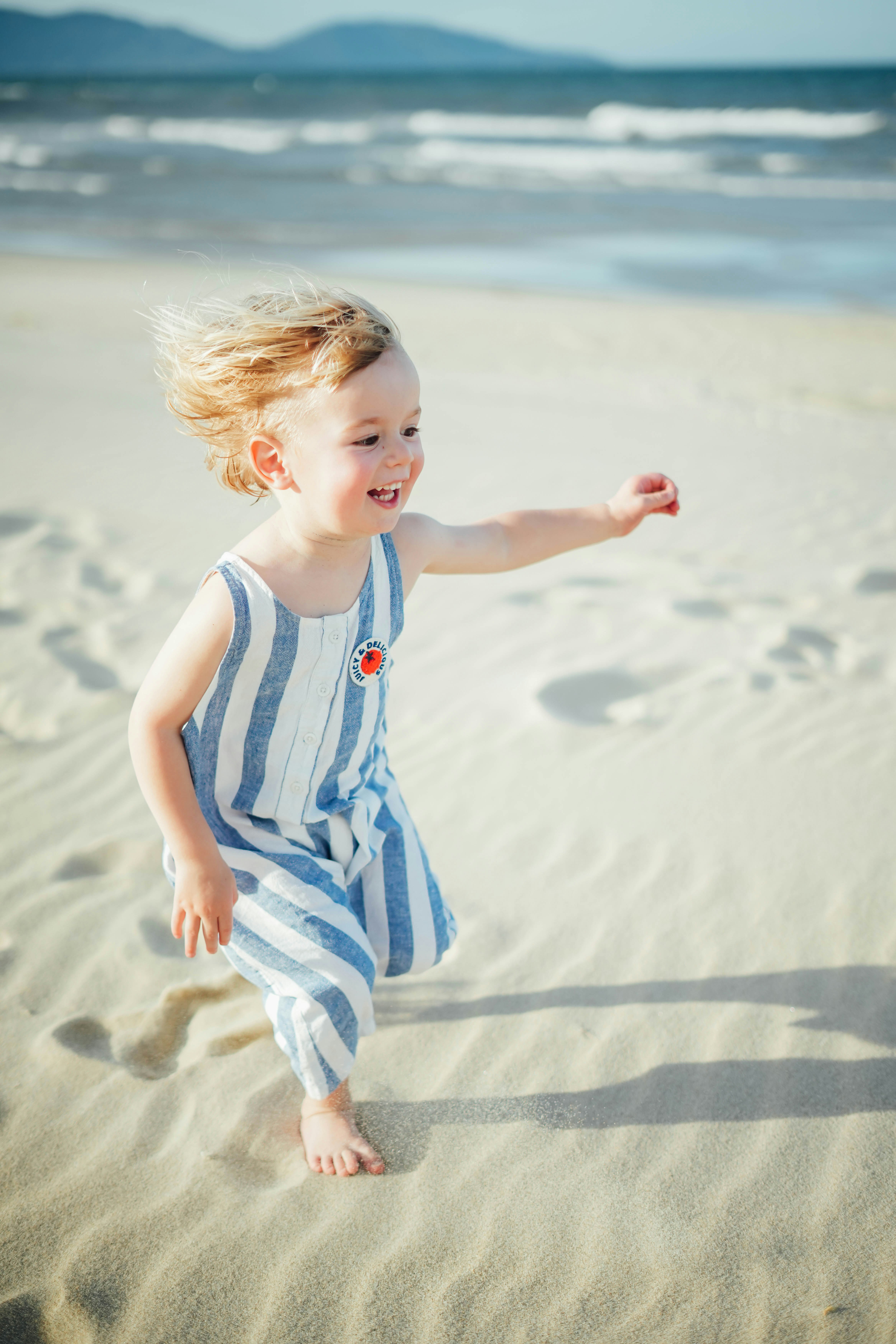 Joyful Run on Sunny Sand: Little One in Blue-White Stripes