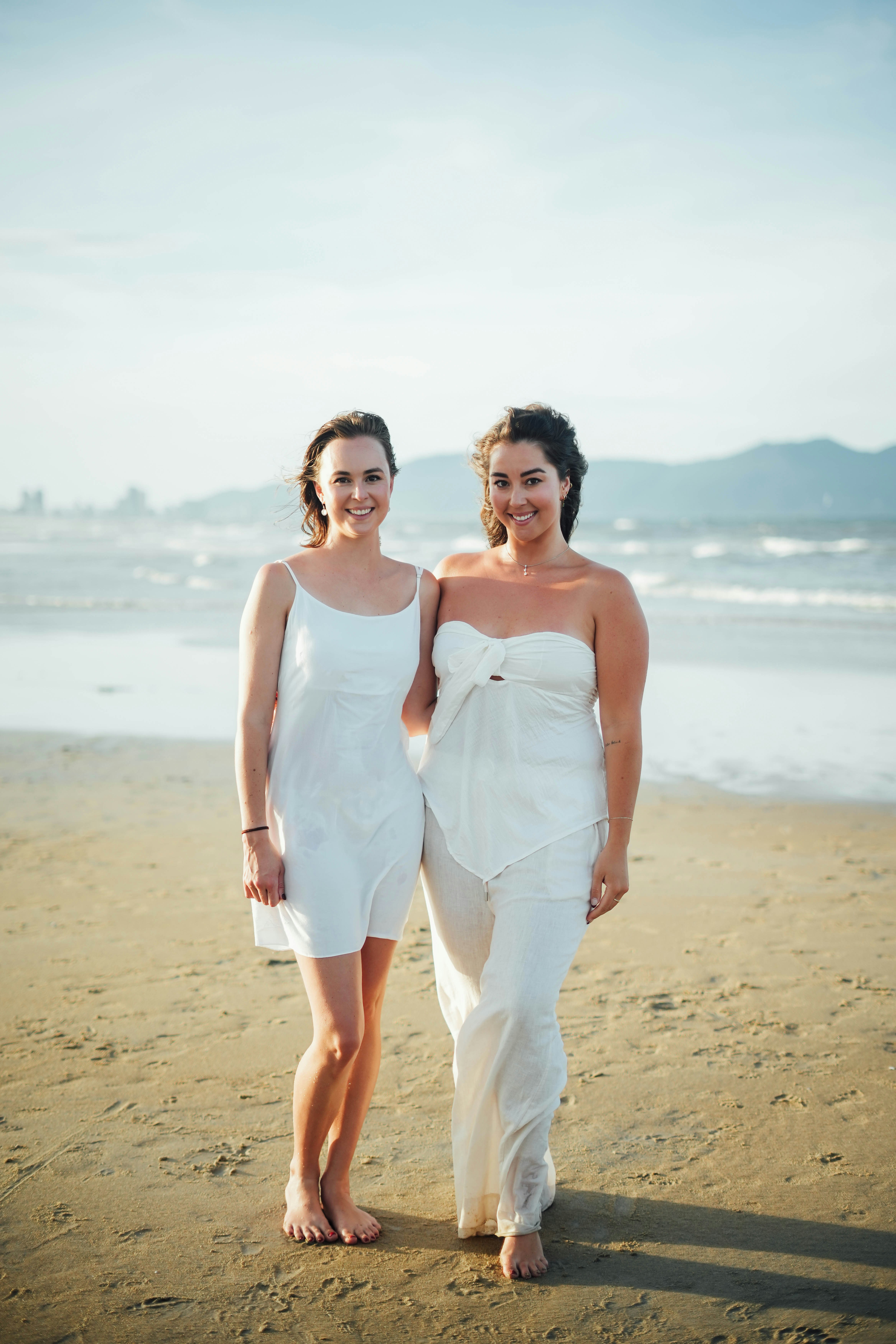 Twin Horizons: Two Friends in White on a Seaside Slackline of Light