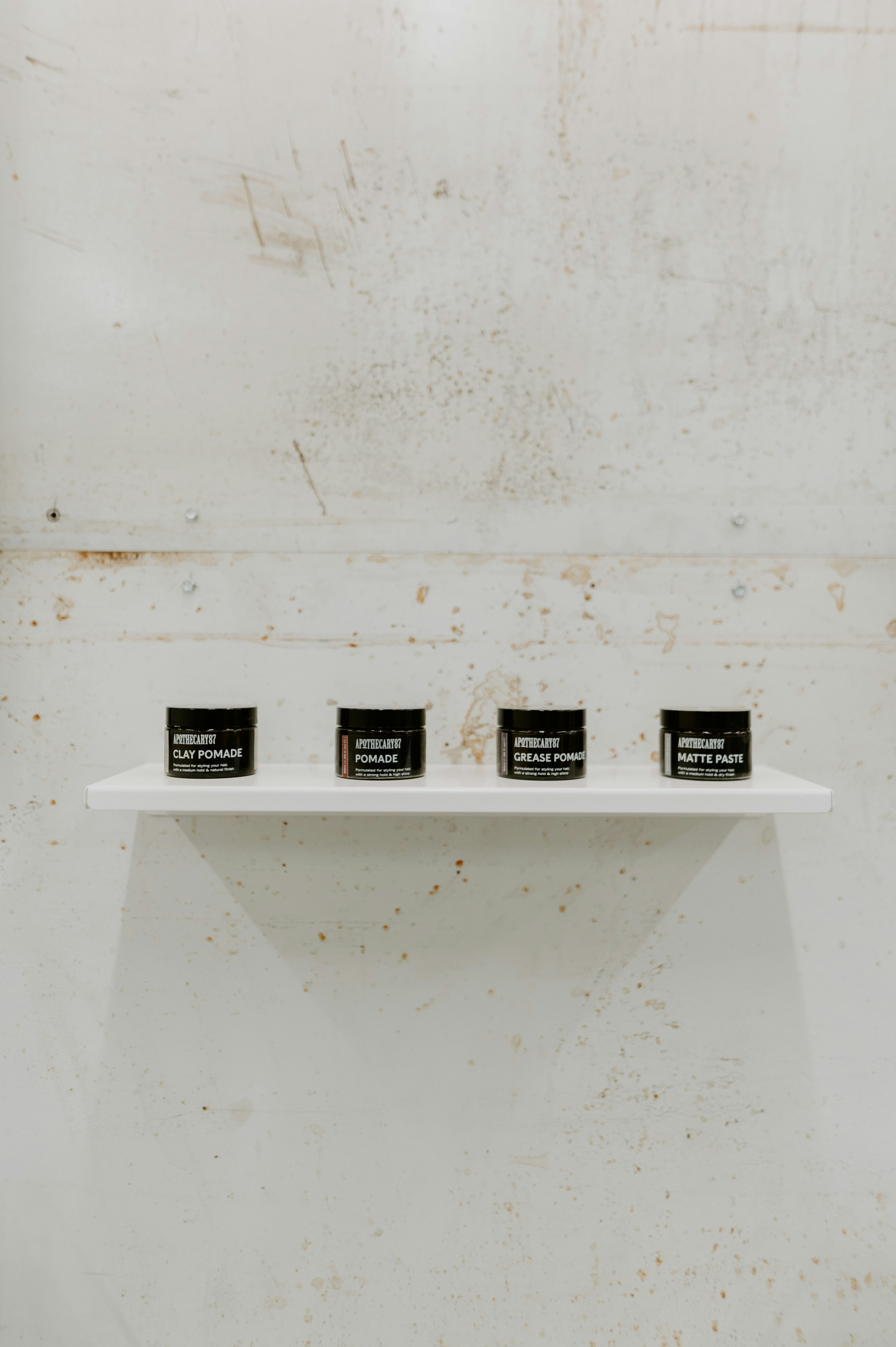 Minimalist Vanity Shelf with Four Black Jars