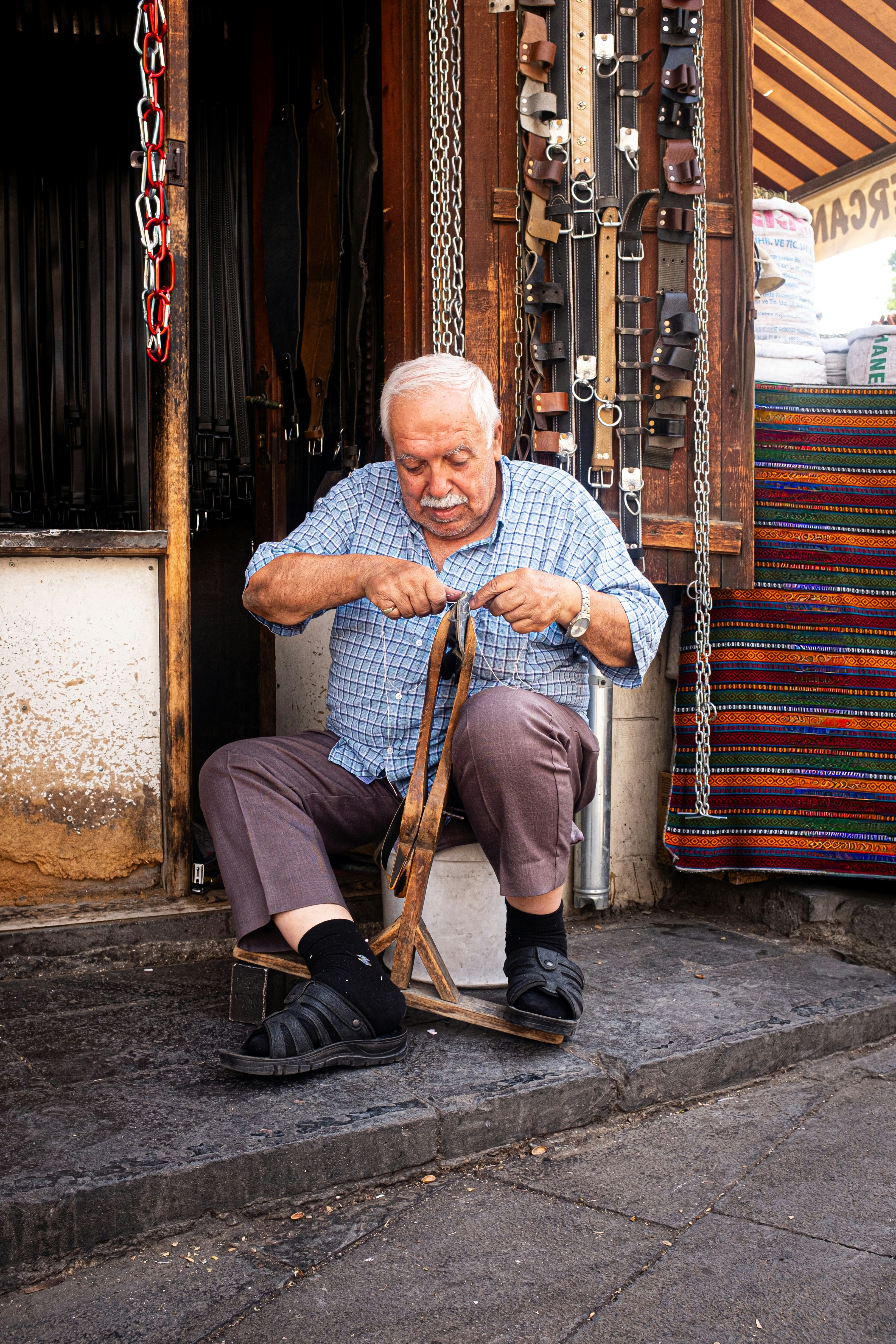 Old Craftsman at Work: Straps and Straps in a Busy Shopfront