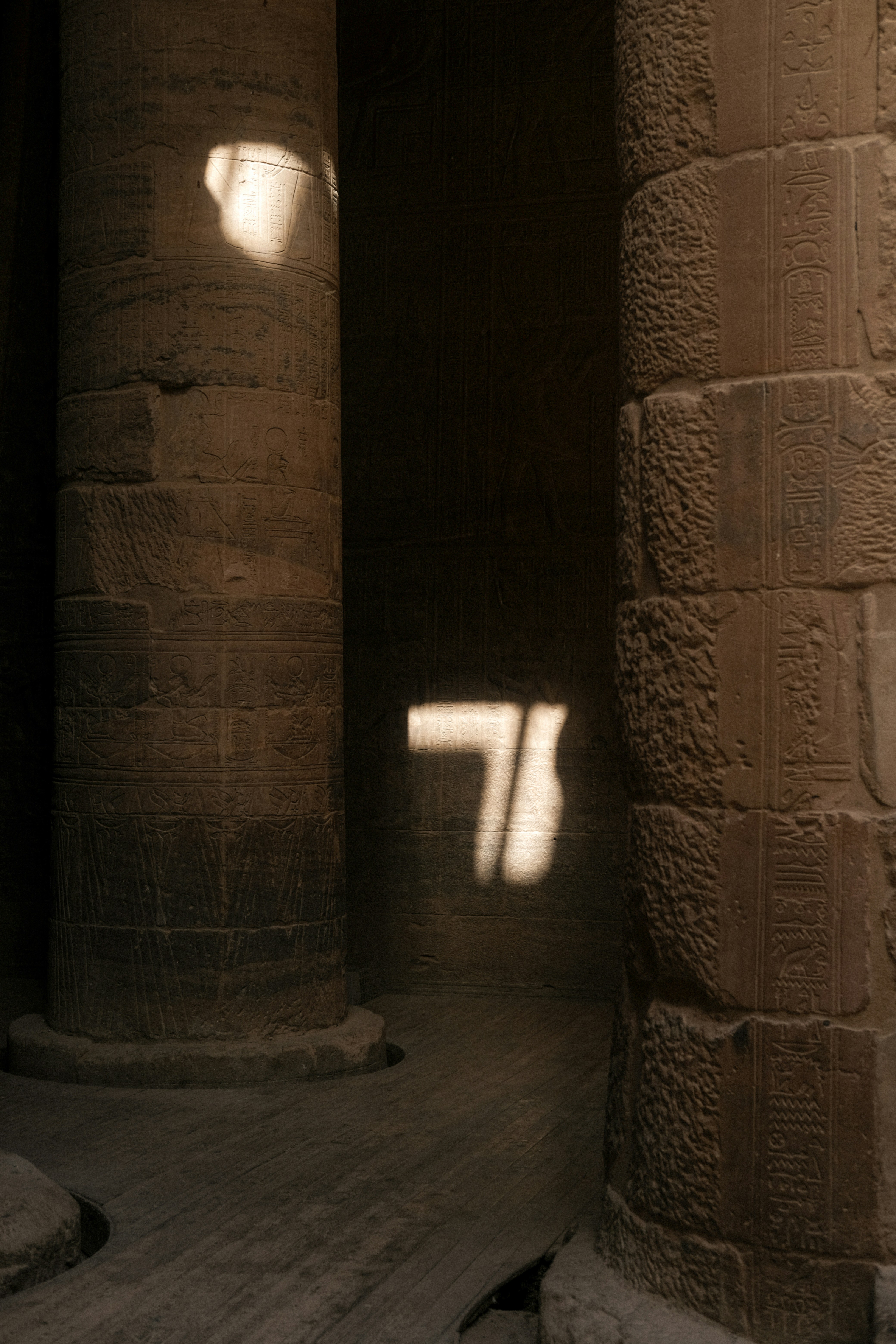 Shadowed Pillars and a Glimpse of Light: Ancient Corridor
