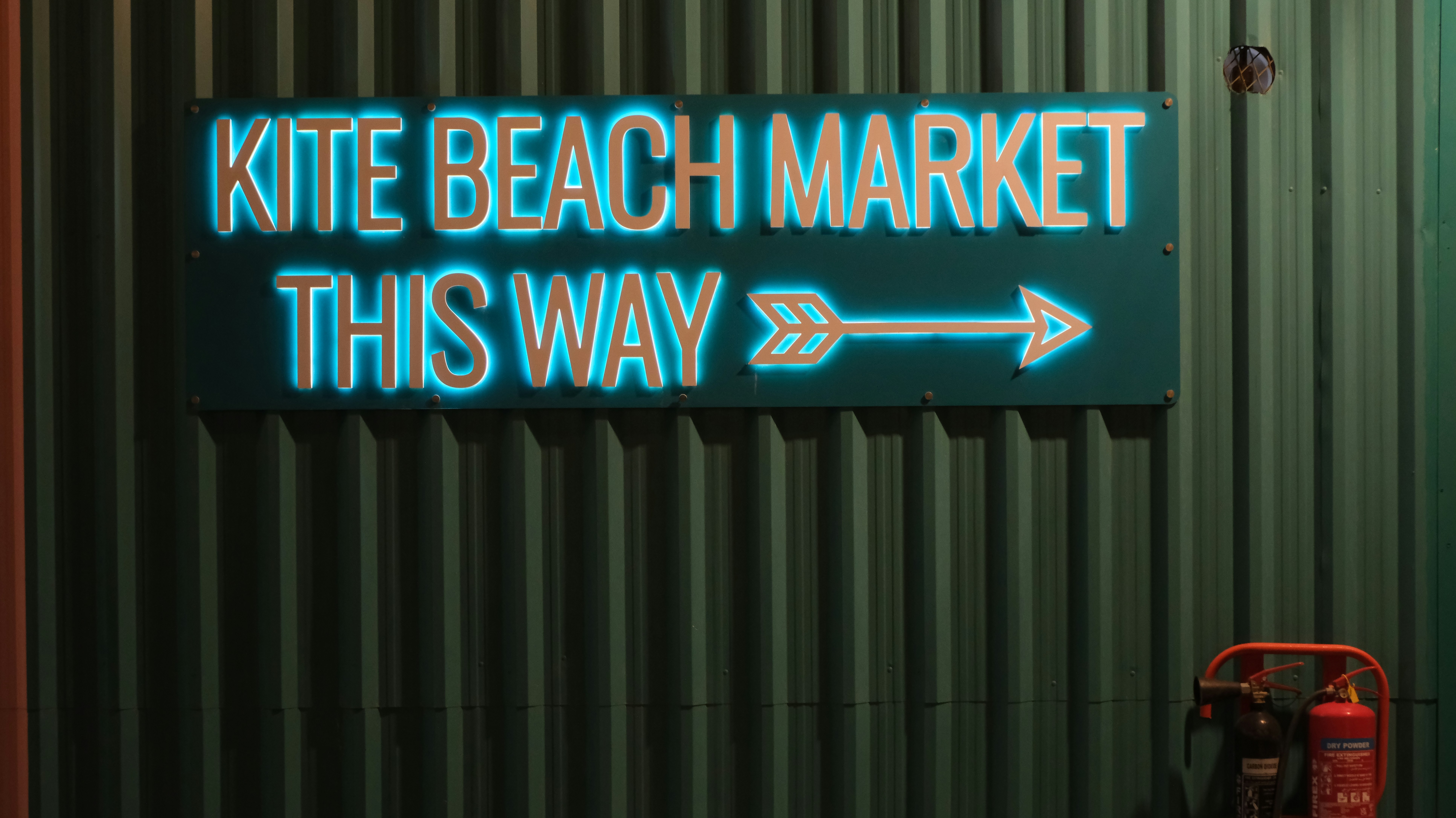 Neon Arrow to the Market: A Midnight Signboard Glow