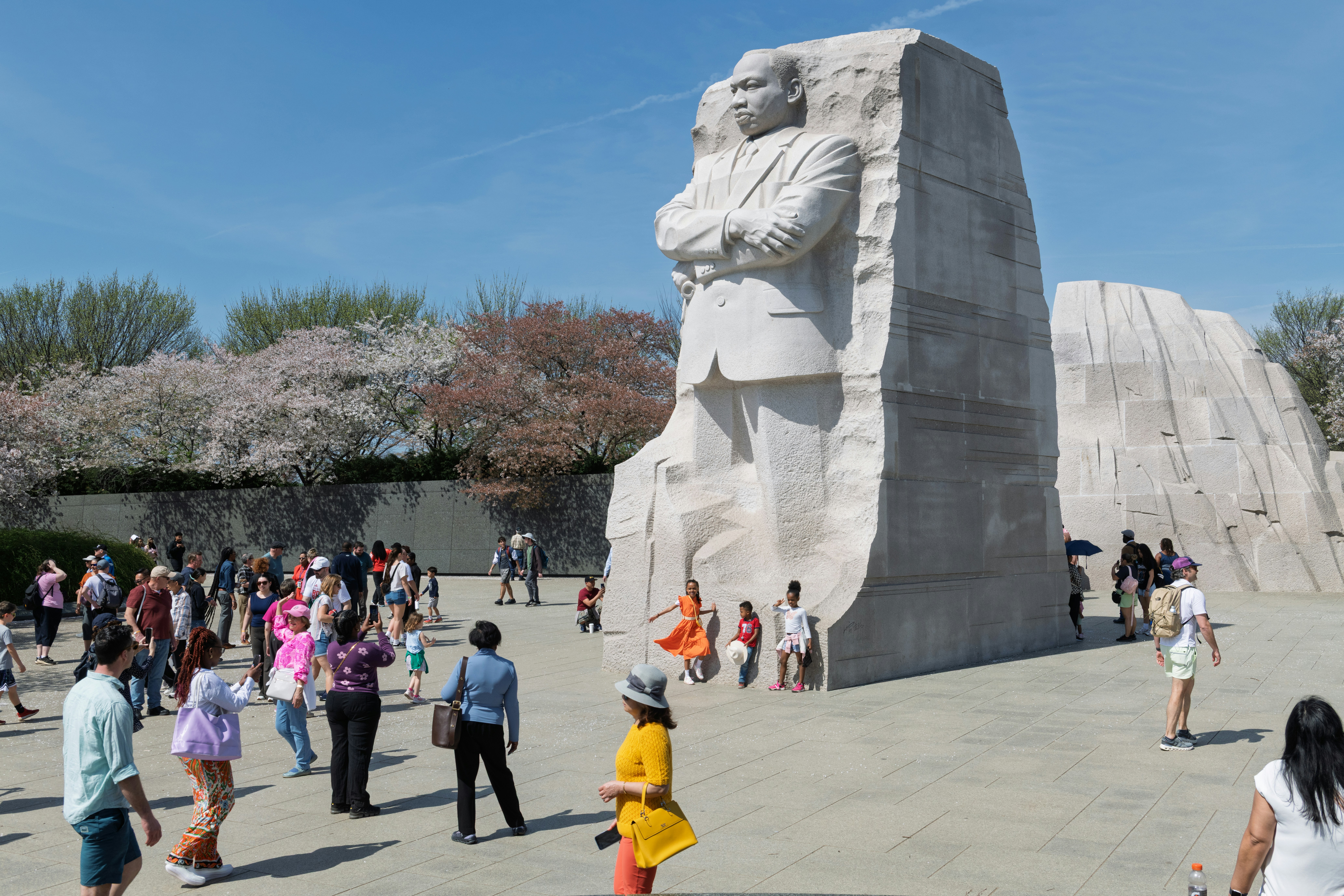 Visitors gather at the colossal statue of a statesman carved from stone