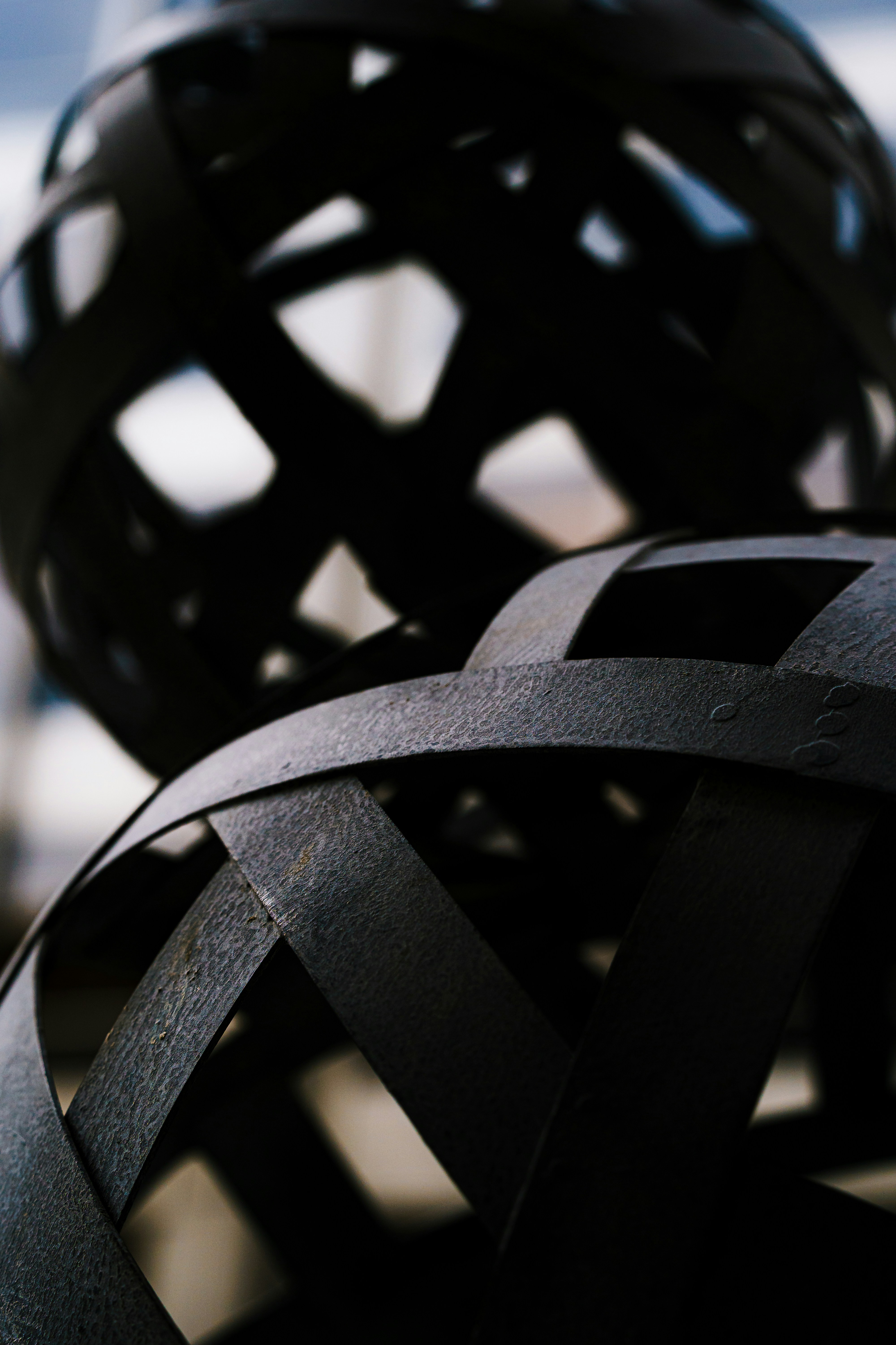Interwoven Metal Orbs: A Study in Rust and Form