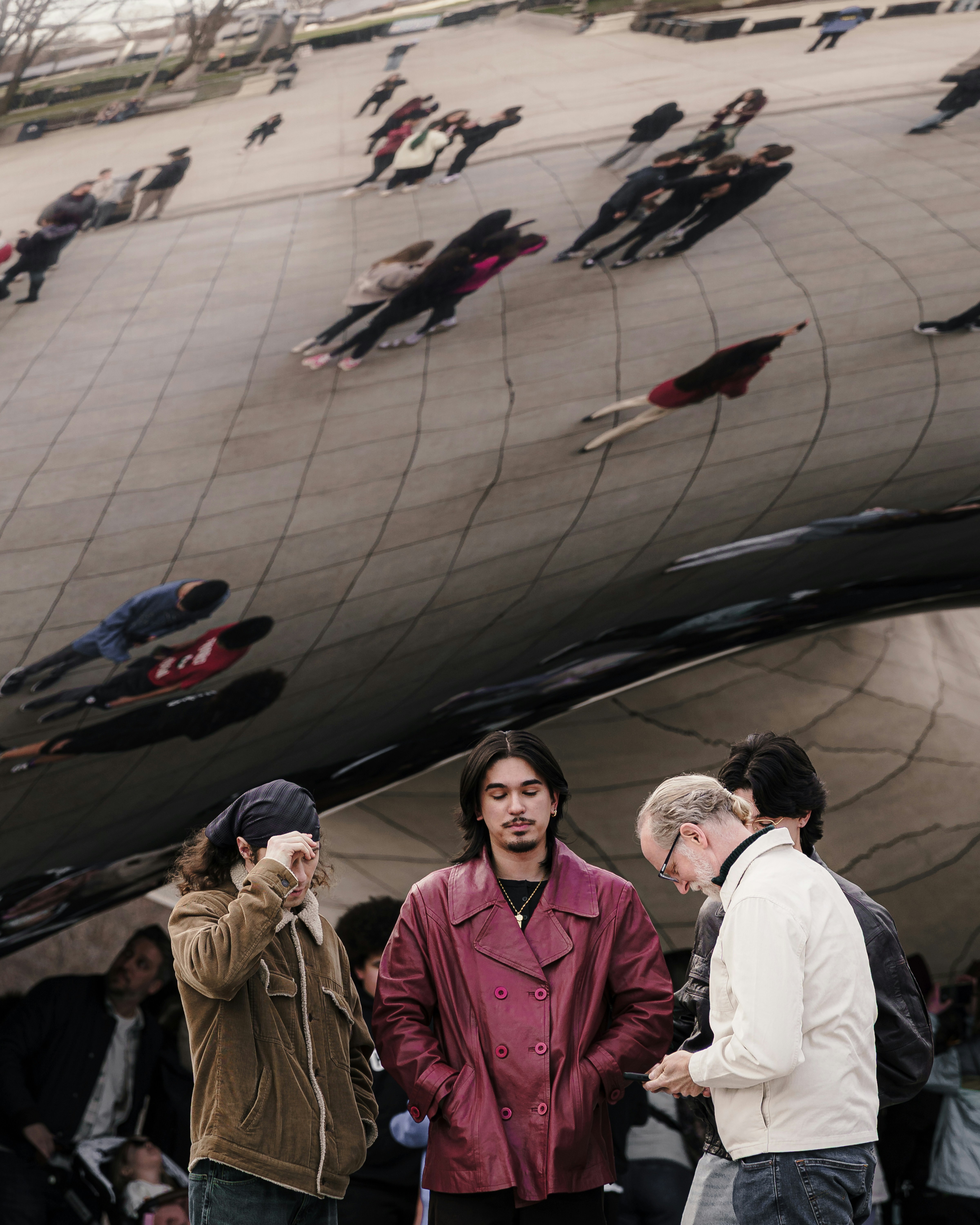 Reflected Moments: People Gathered Beneath a Curved Monochrome Surface