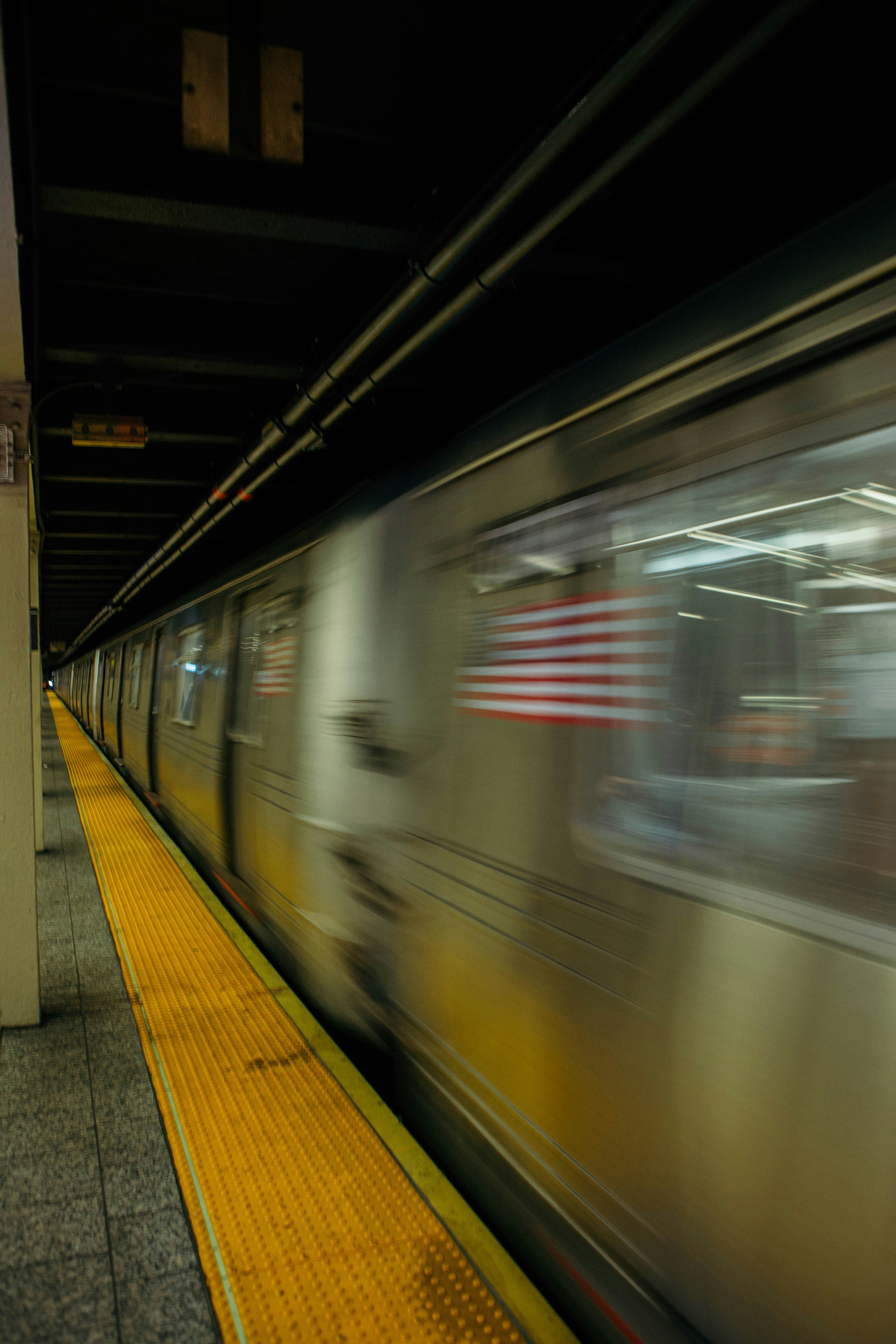 Blurry Metro Glide: A Yellow-Tilled Platform Slices the Night