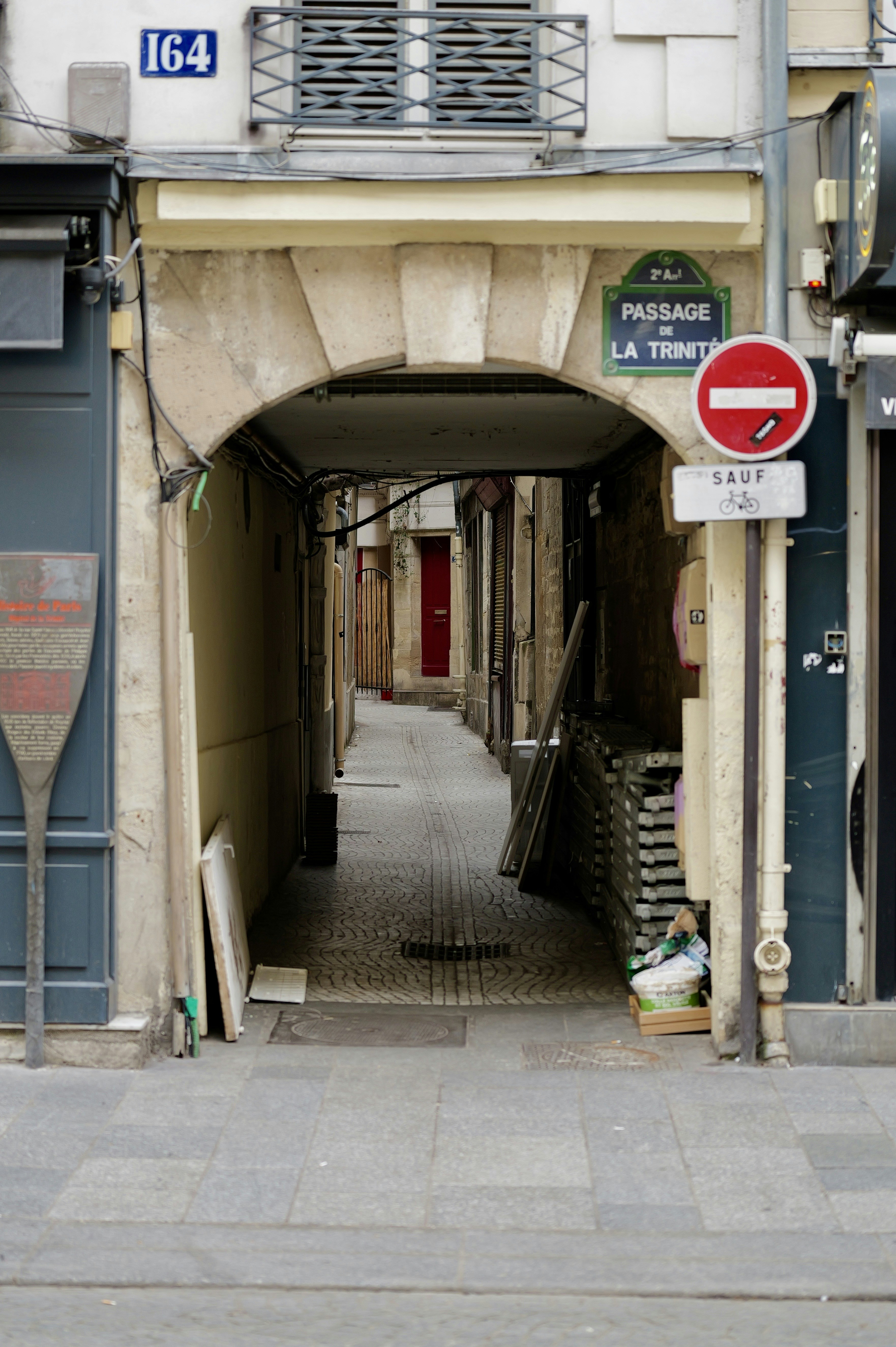 Narrow Parisian Archway: Light at the End of the Passage