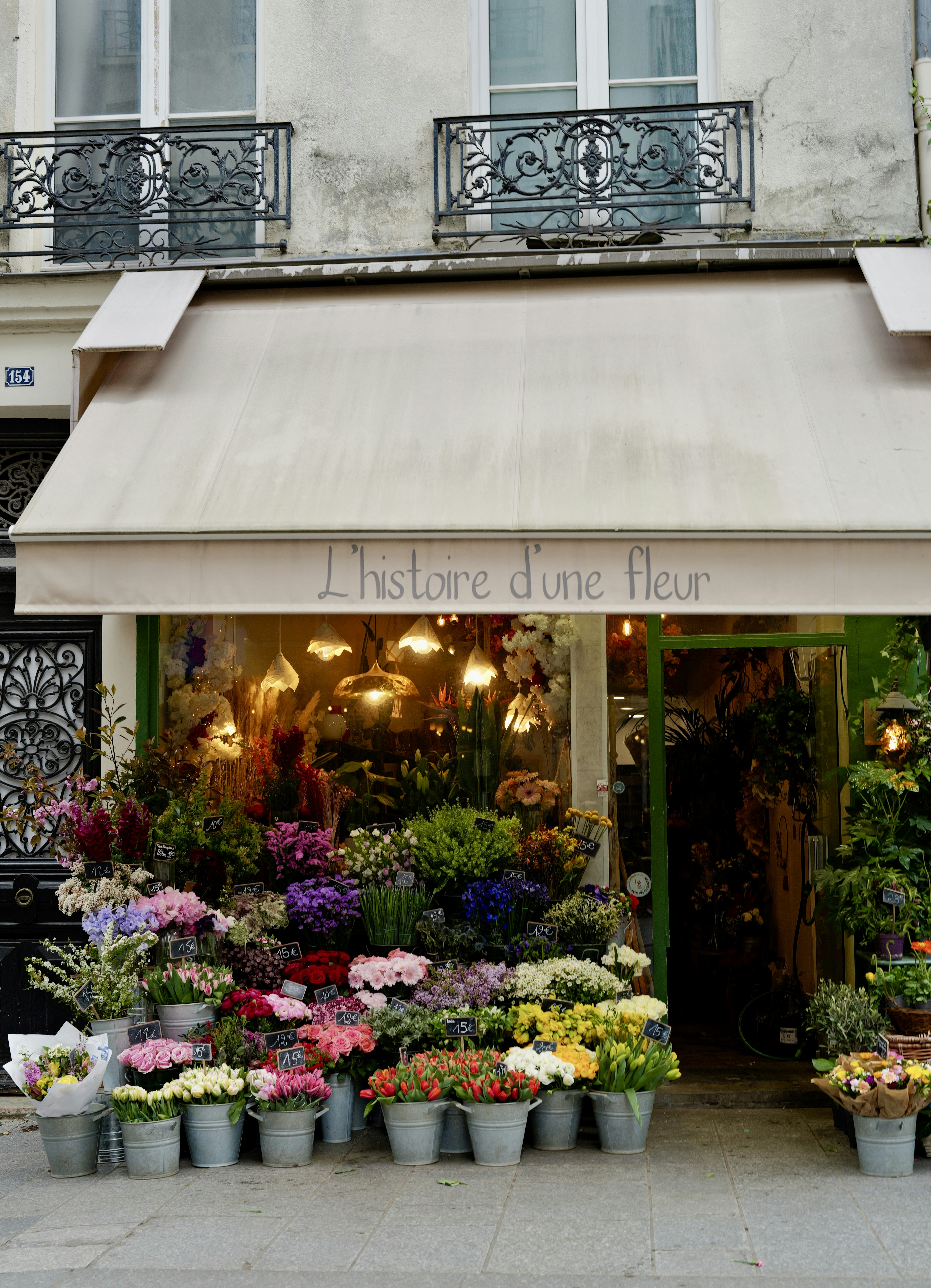 A Blooming Shopfront Under a Muted Awnings