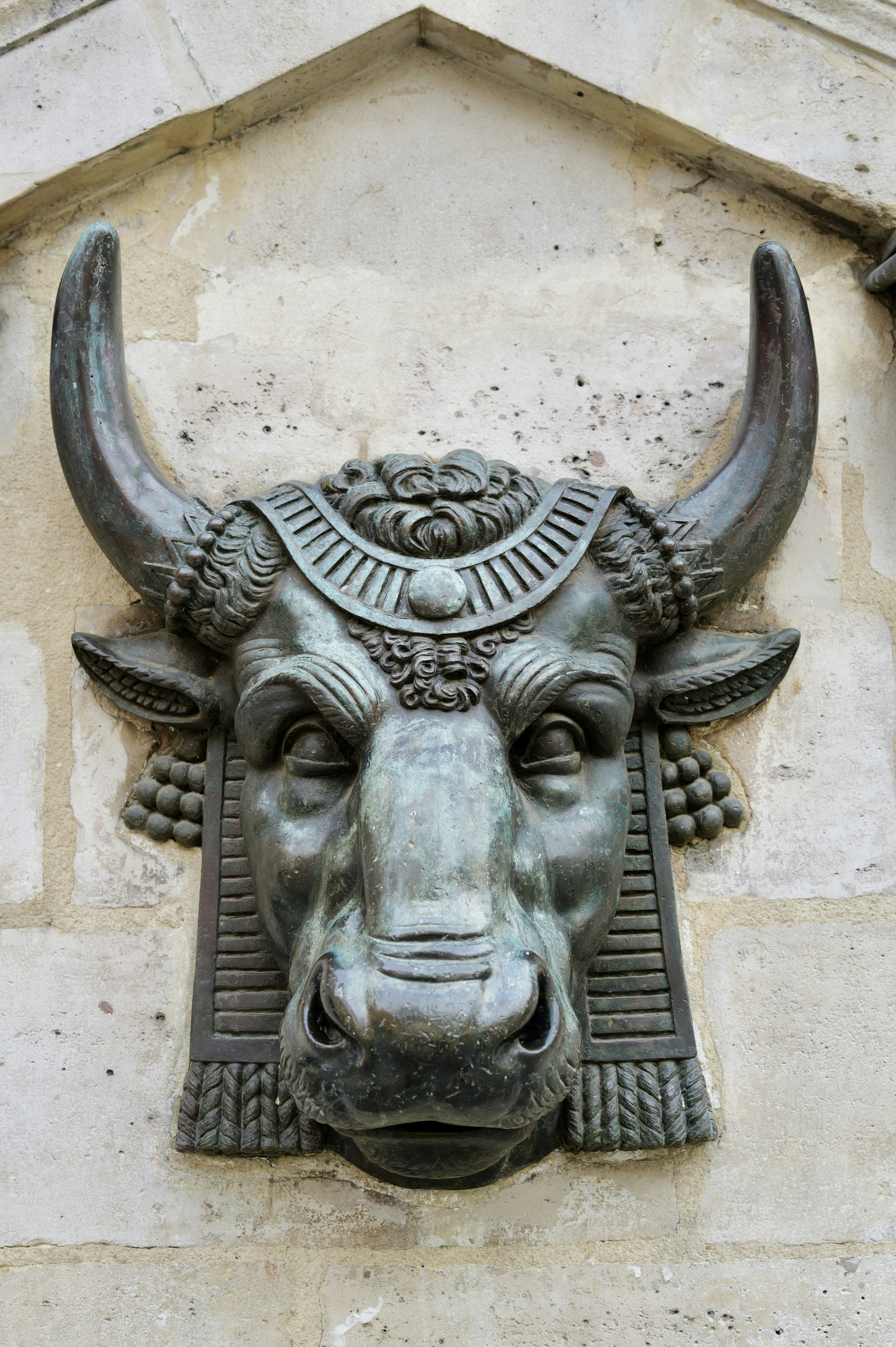 Bronze Bull Mask Anchored in Stone: A Regal Facade