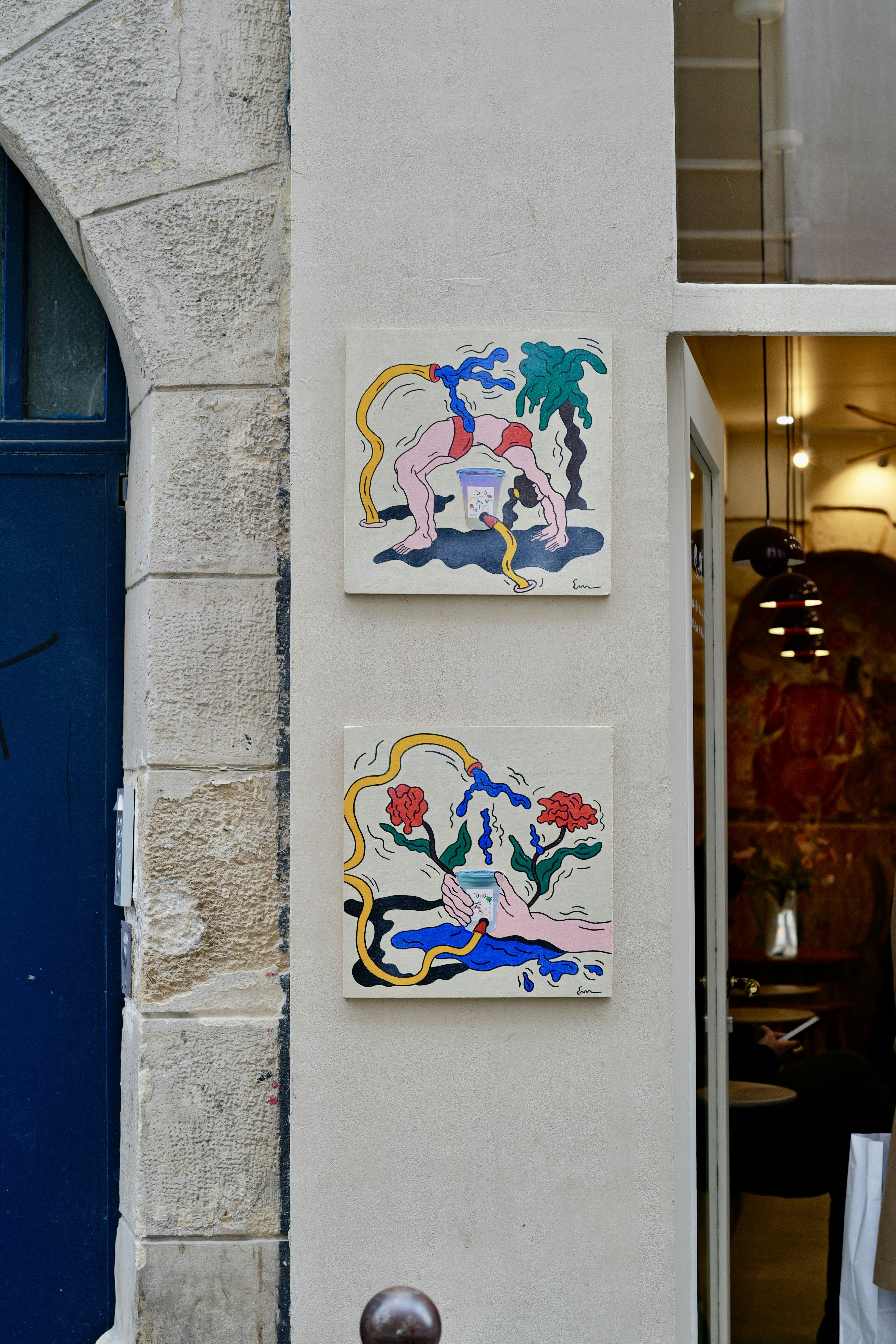 Two Art Panels on a Light-Colored Wall beside a Doorway