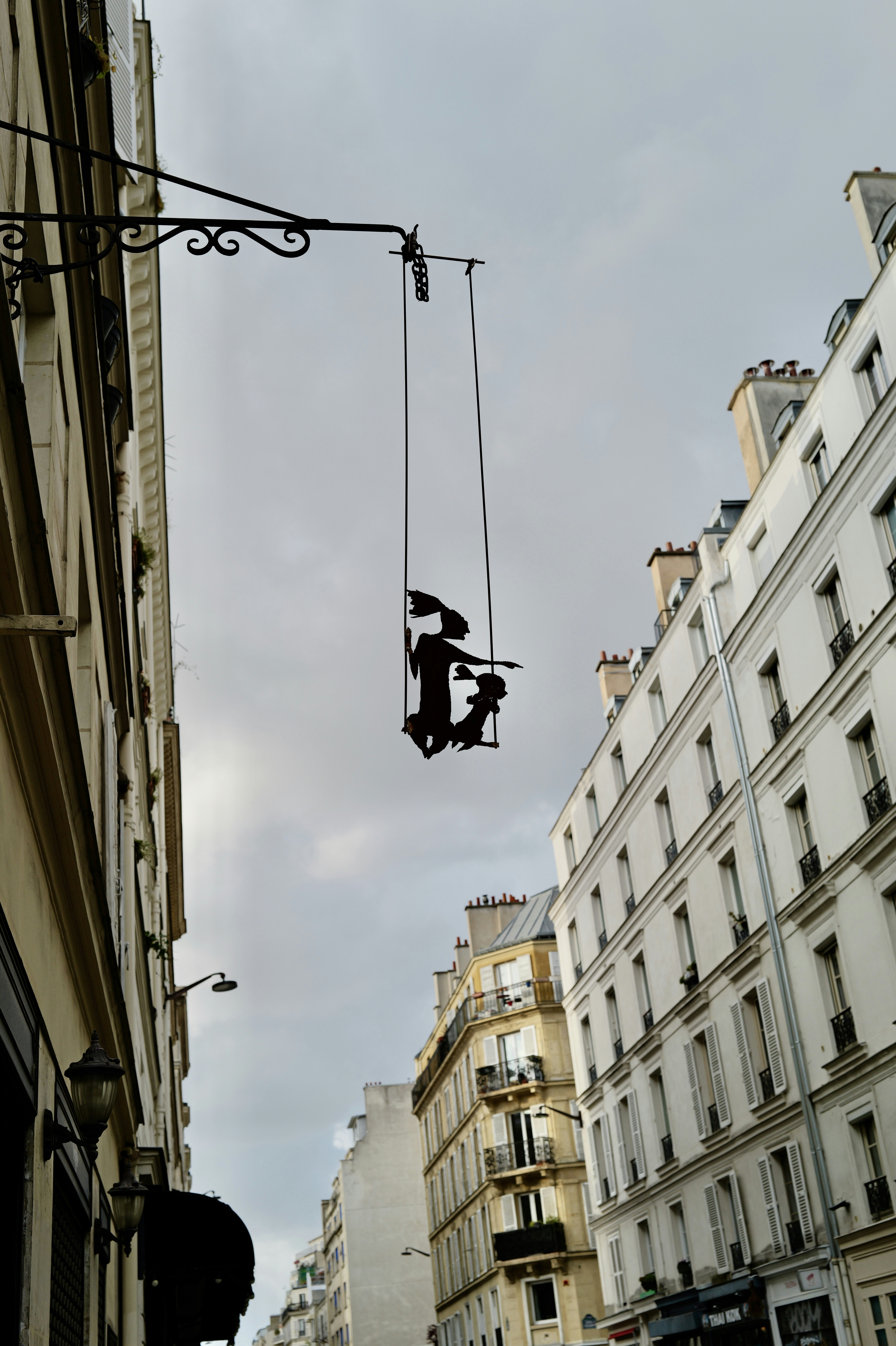 Suspended Shadow-play: A Wink of Wind Over Parisian Facades