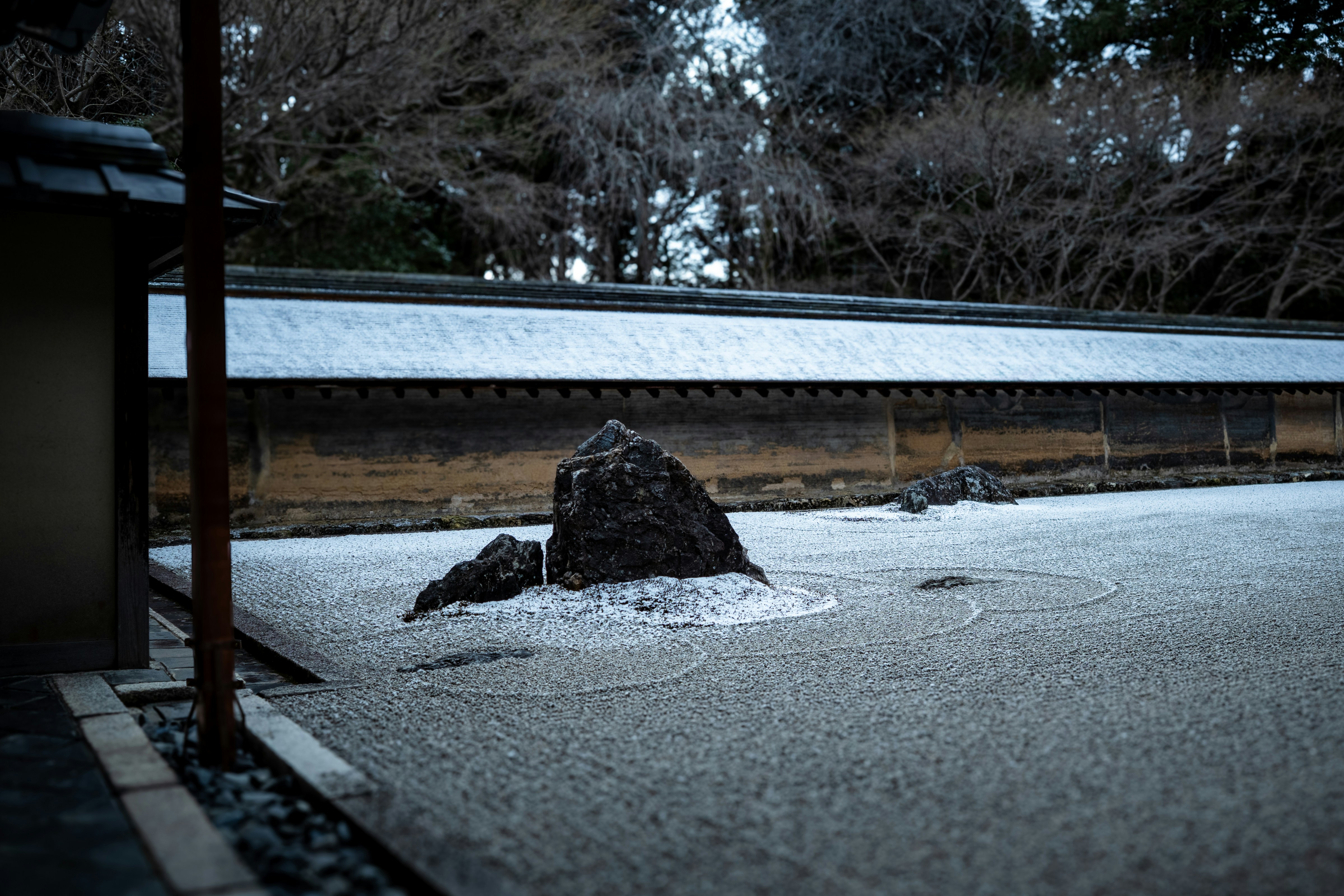 Quiet Gravel Garden with Center Stone and Wall