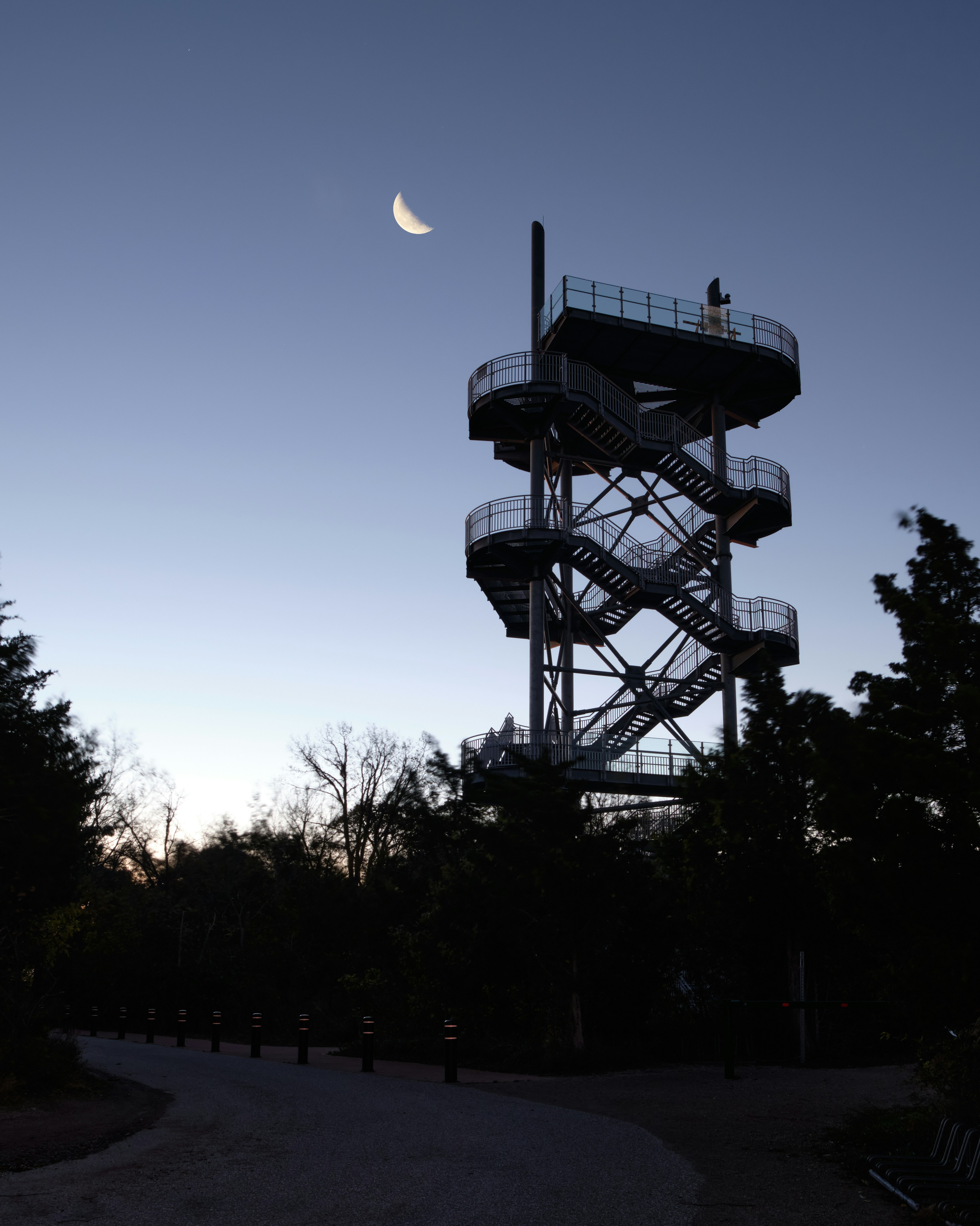 Moonlit Skyline: The Fire Tower Against Evening Sky