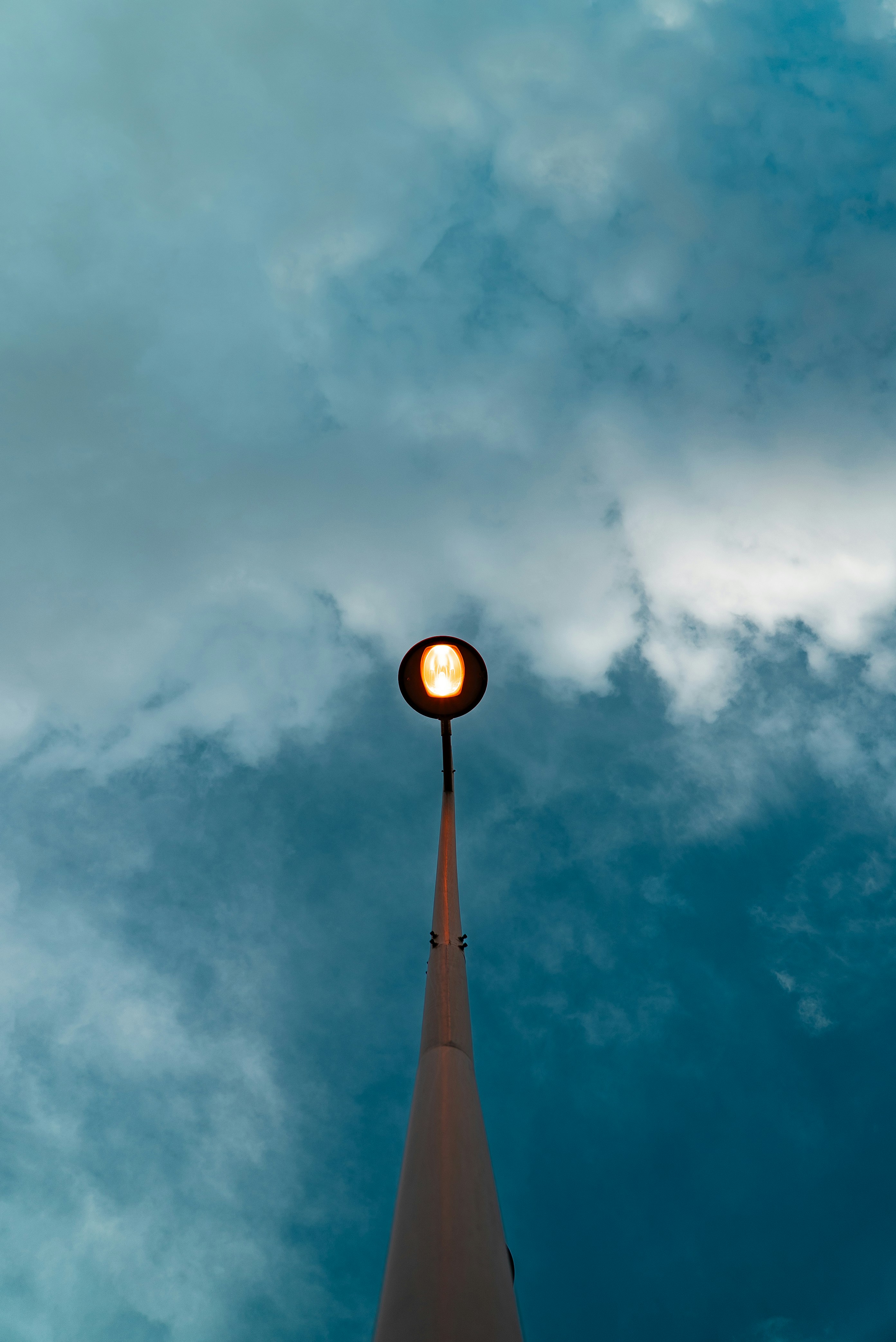 Pole Star: A Lone Street Lamp Reaching Toward a Skyscape
