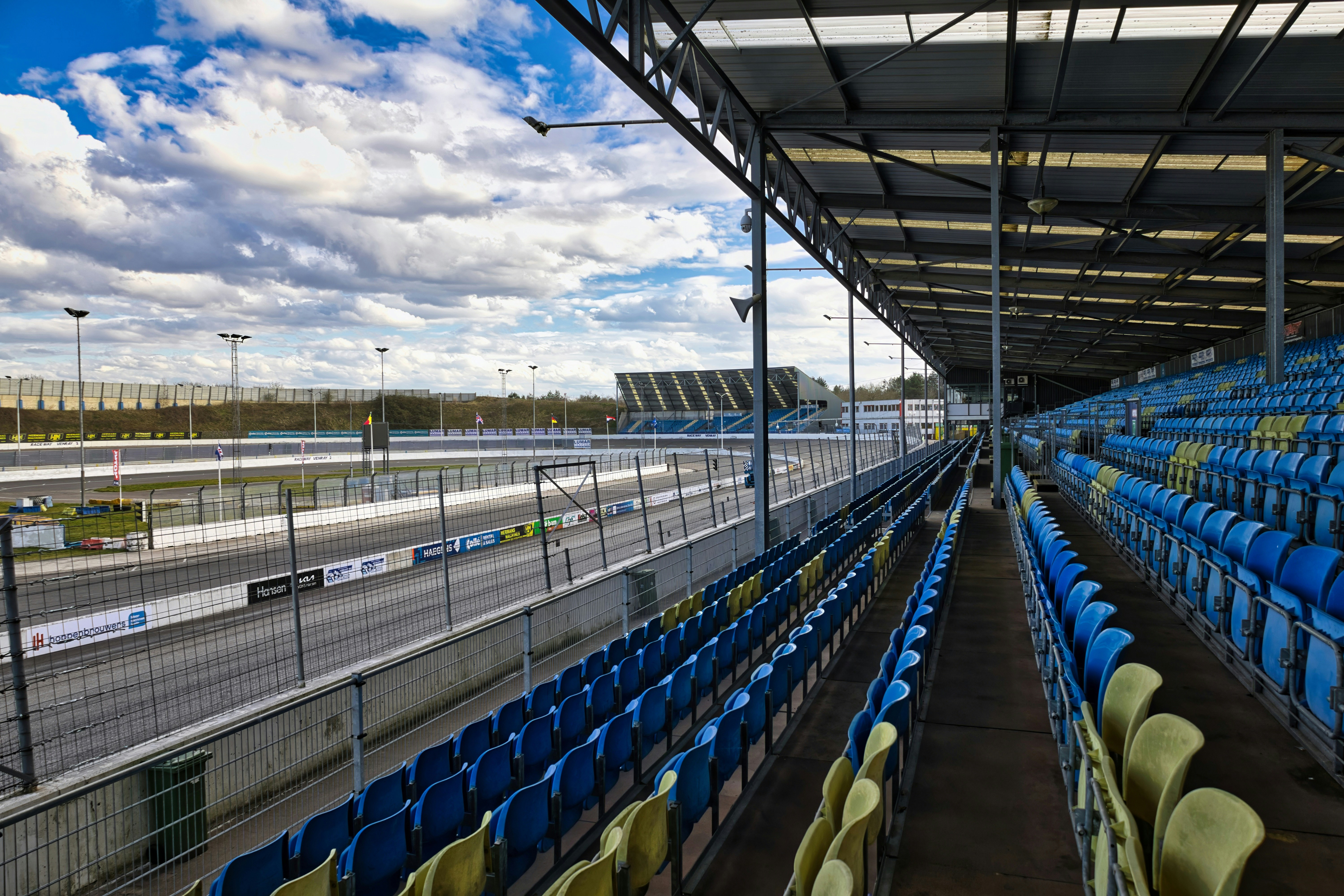 Stadium Corridor: Blue and Yellow Seats Overlooking the Track